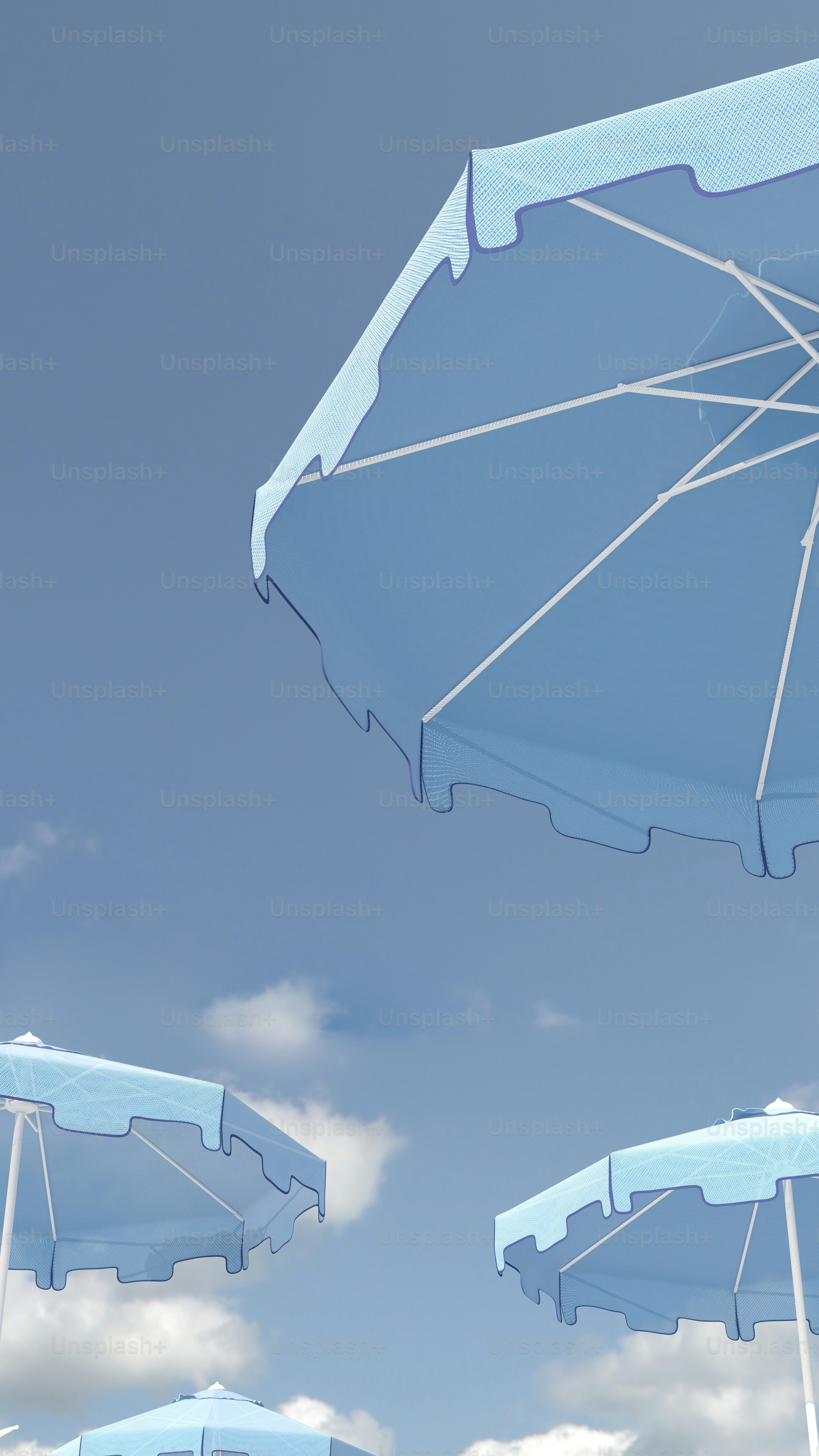 A group of blue umbrellas sitting on top of a sandy beach photo ...