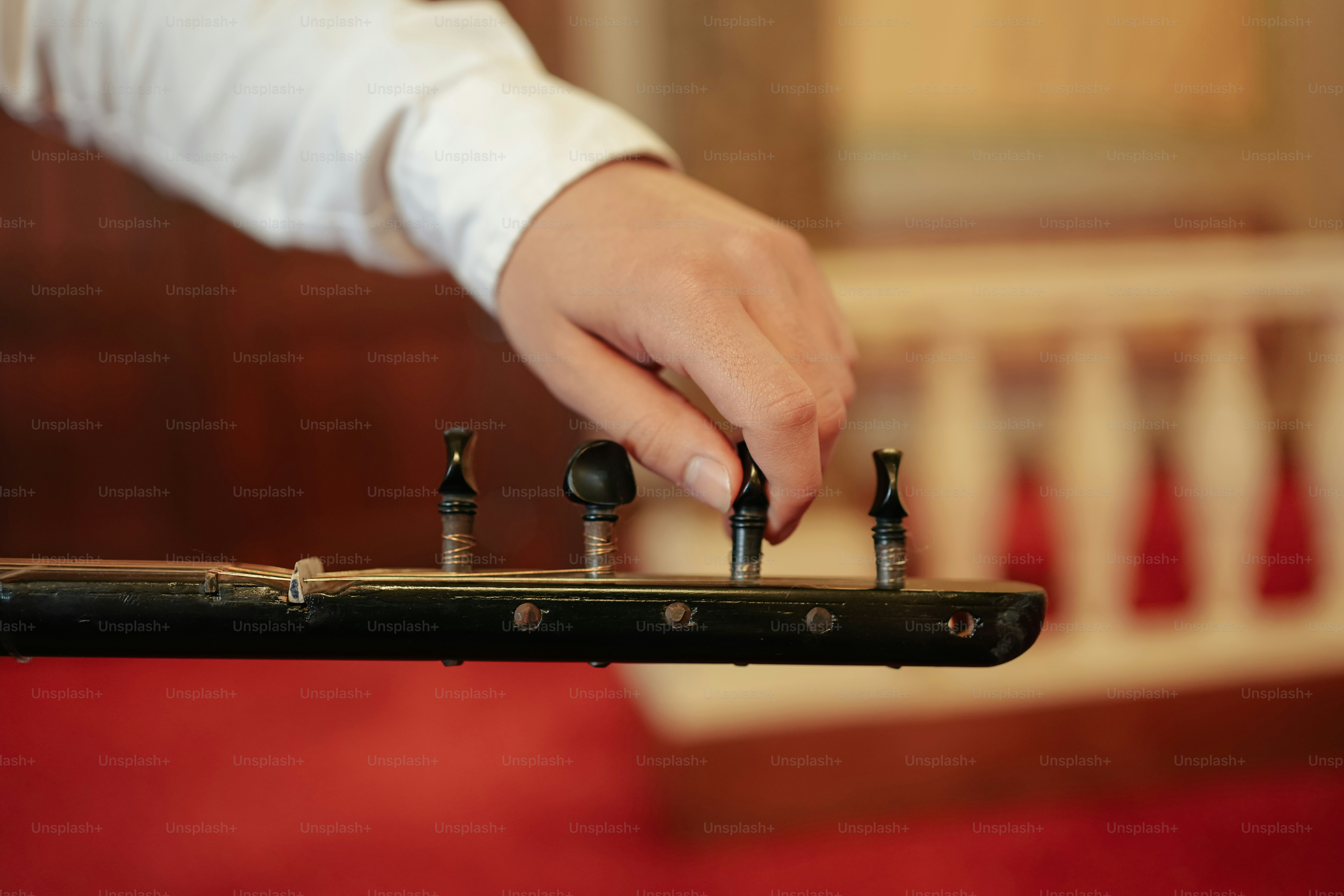 A person playing a musical instrument with several knobs photo – Male ...
