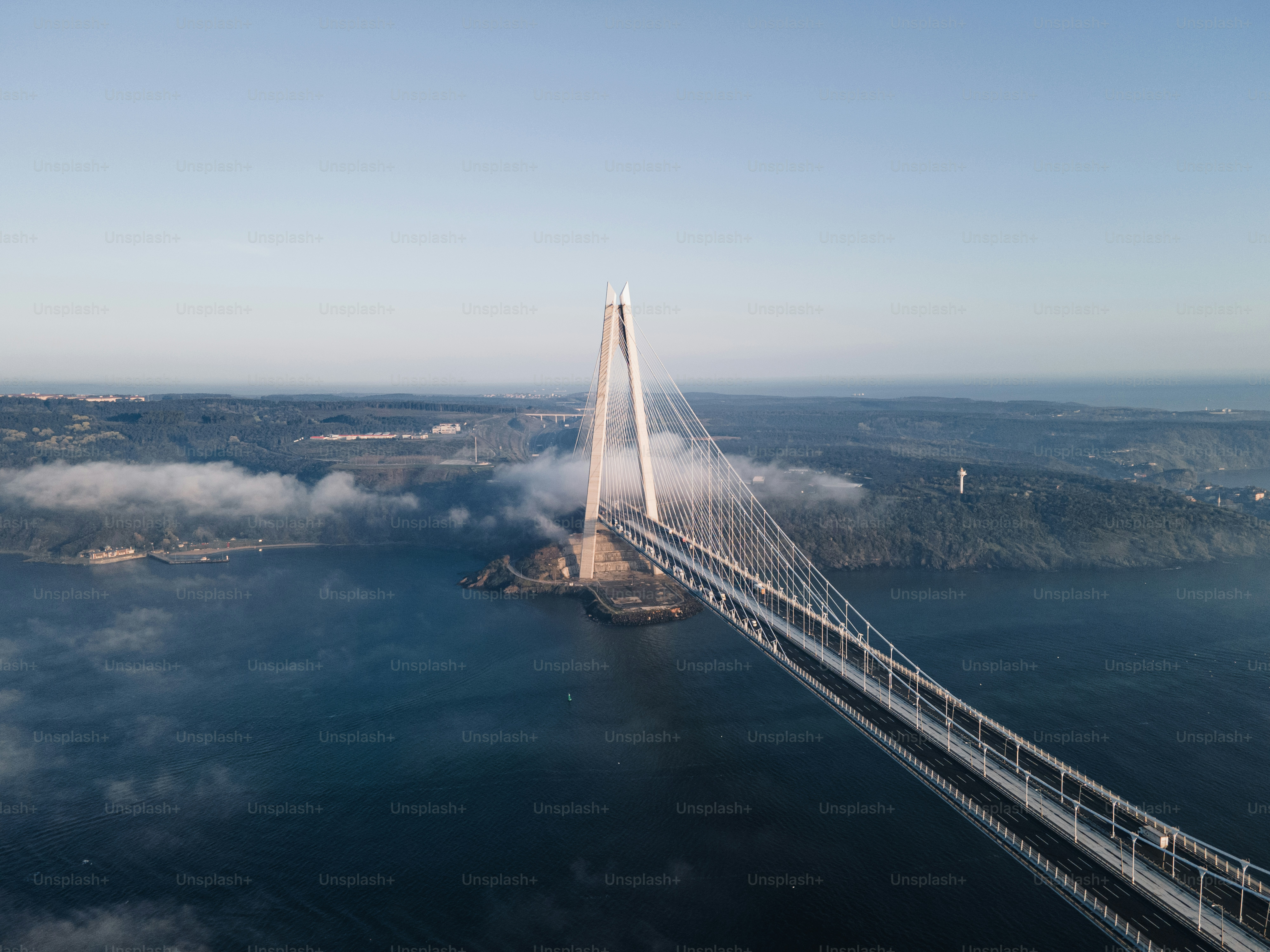 An aerial view of a bridge surrounded by clouds photo – Urban Image on ...