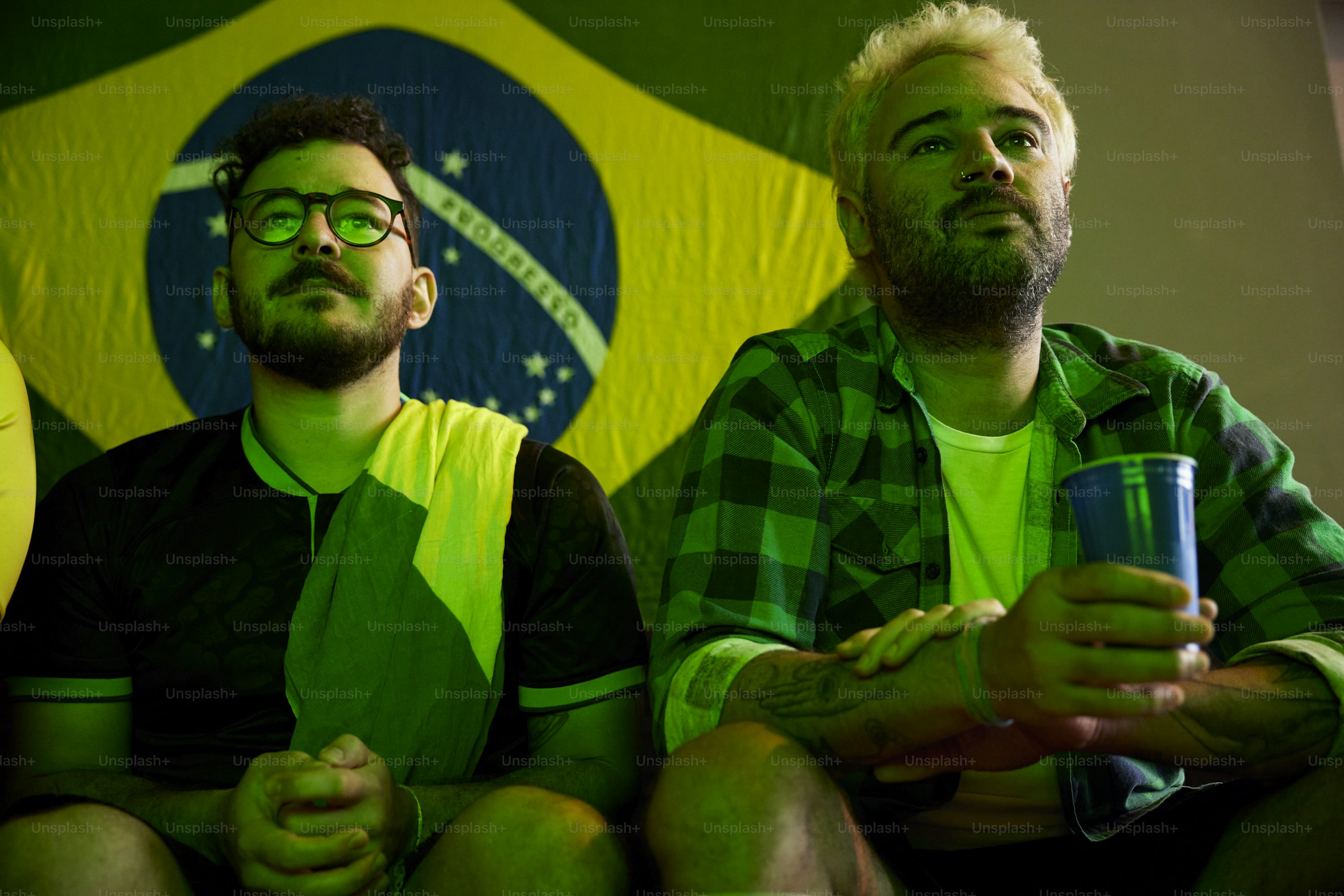 A group of men sitting next to each other photo – Men watching tv Image ... A group of men sitting next to each other photo – Men watching tv Image ...