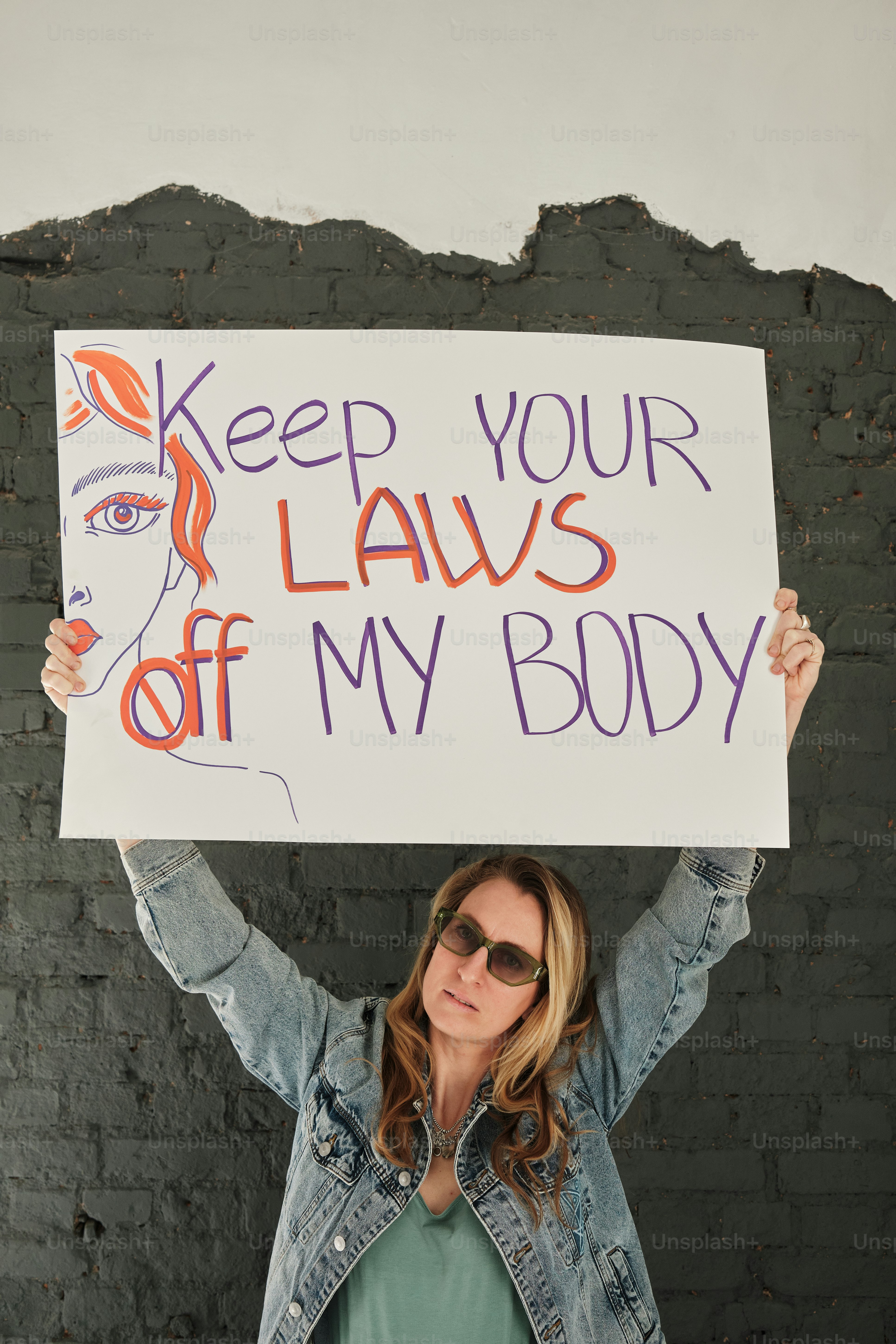 A woman holding a sign that says act now save tomorrow photo – Climate ...