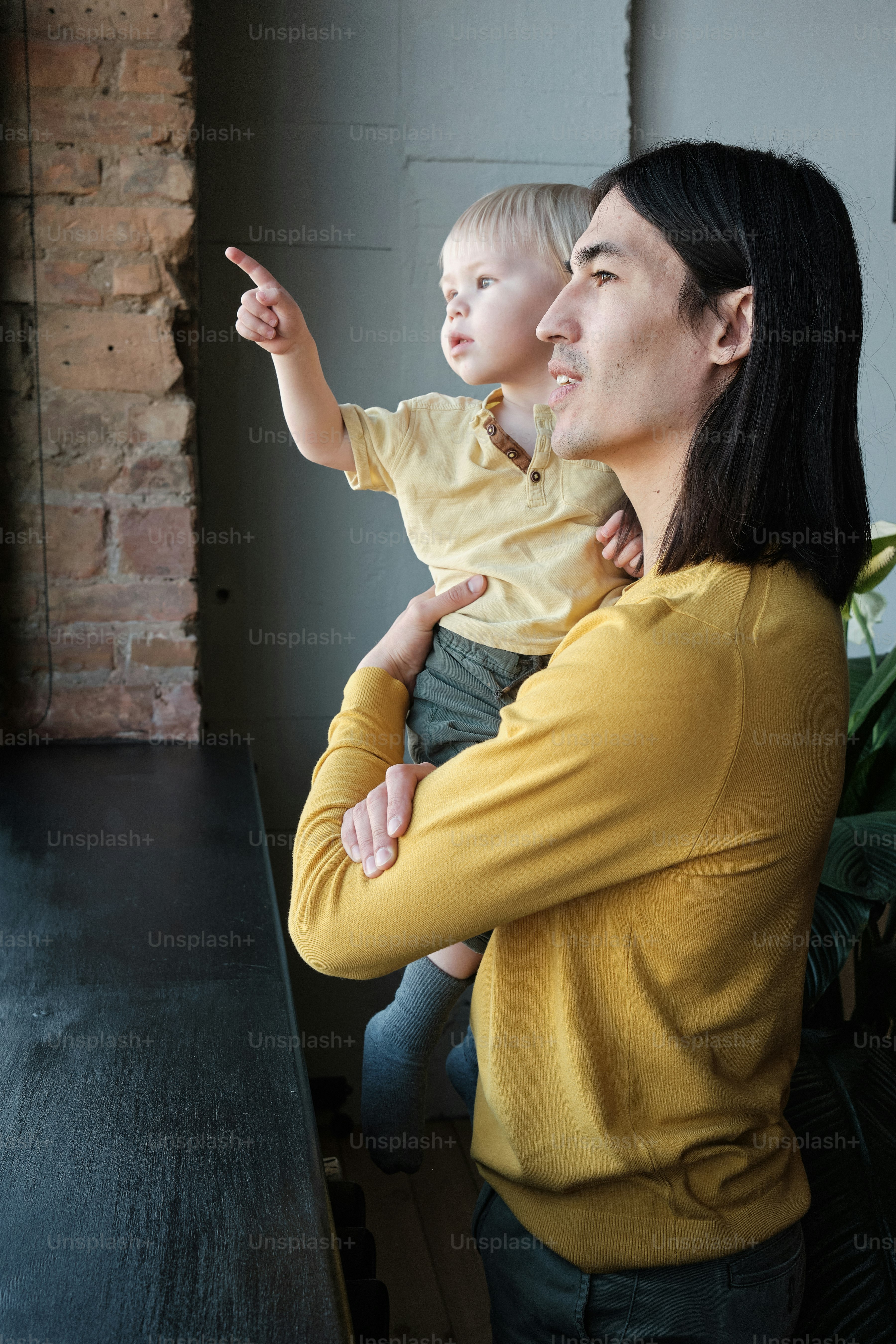 A man holding a child in his arms photo – Asian family Image on Unsplash