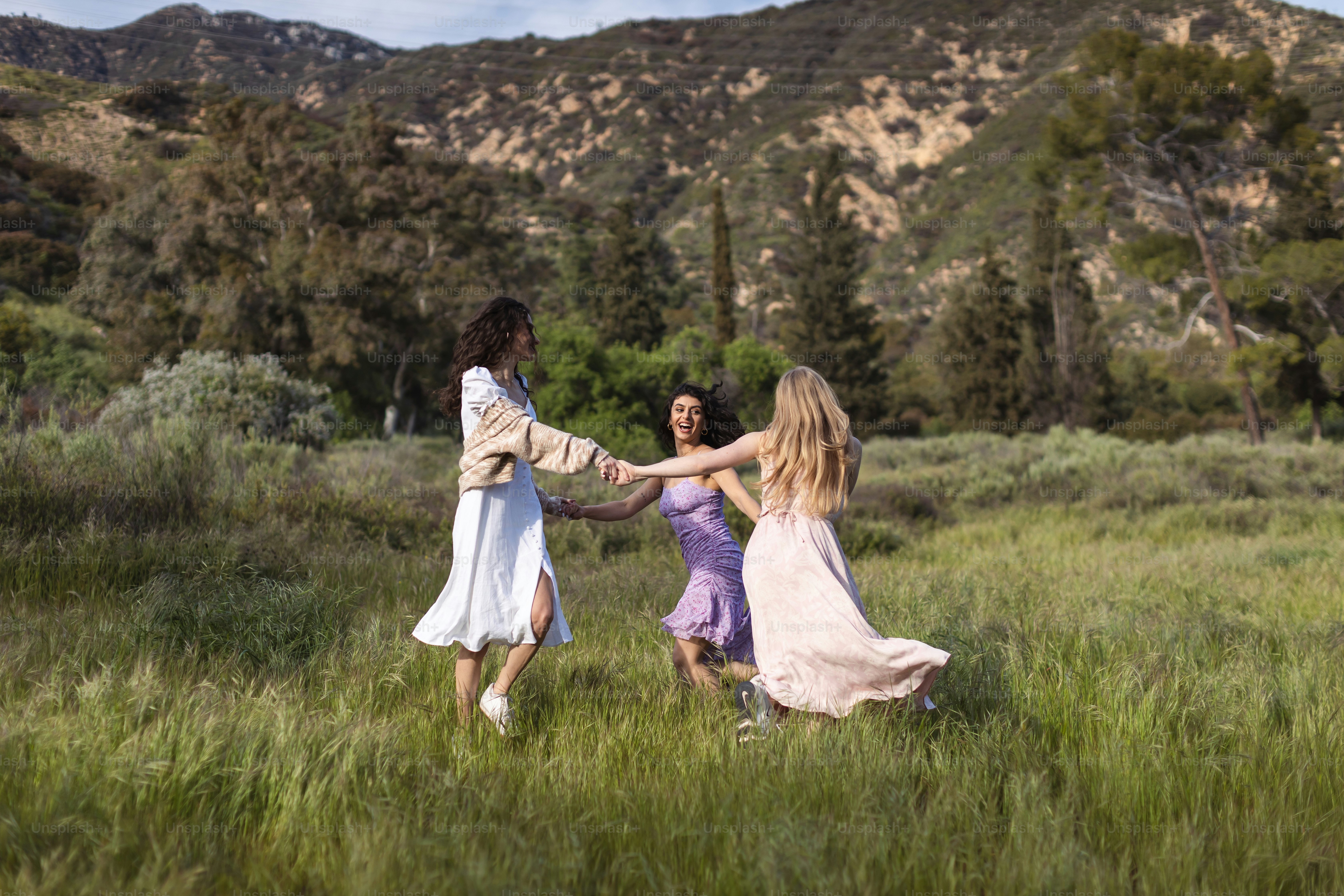 A group of women in a field holding hands photo – Sisterhood Image on ...
