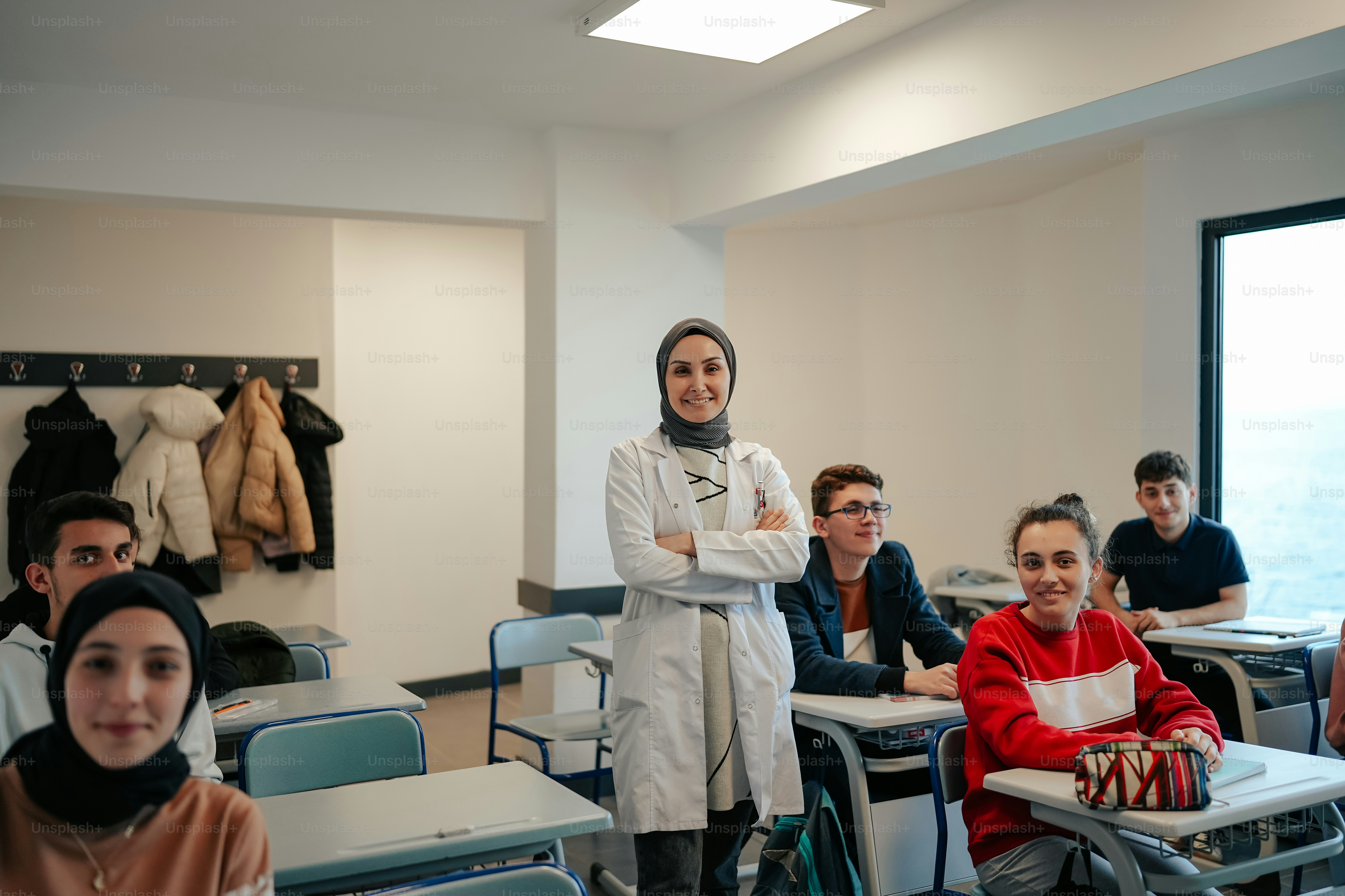 A woman standing in front of a classroom full of students photo ...