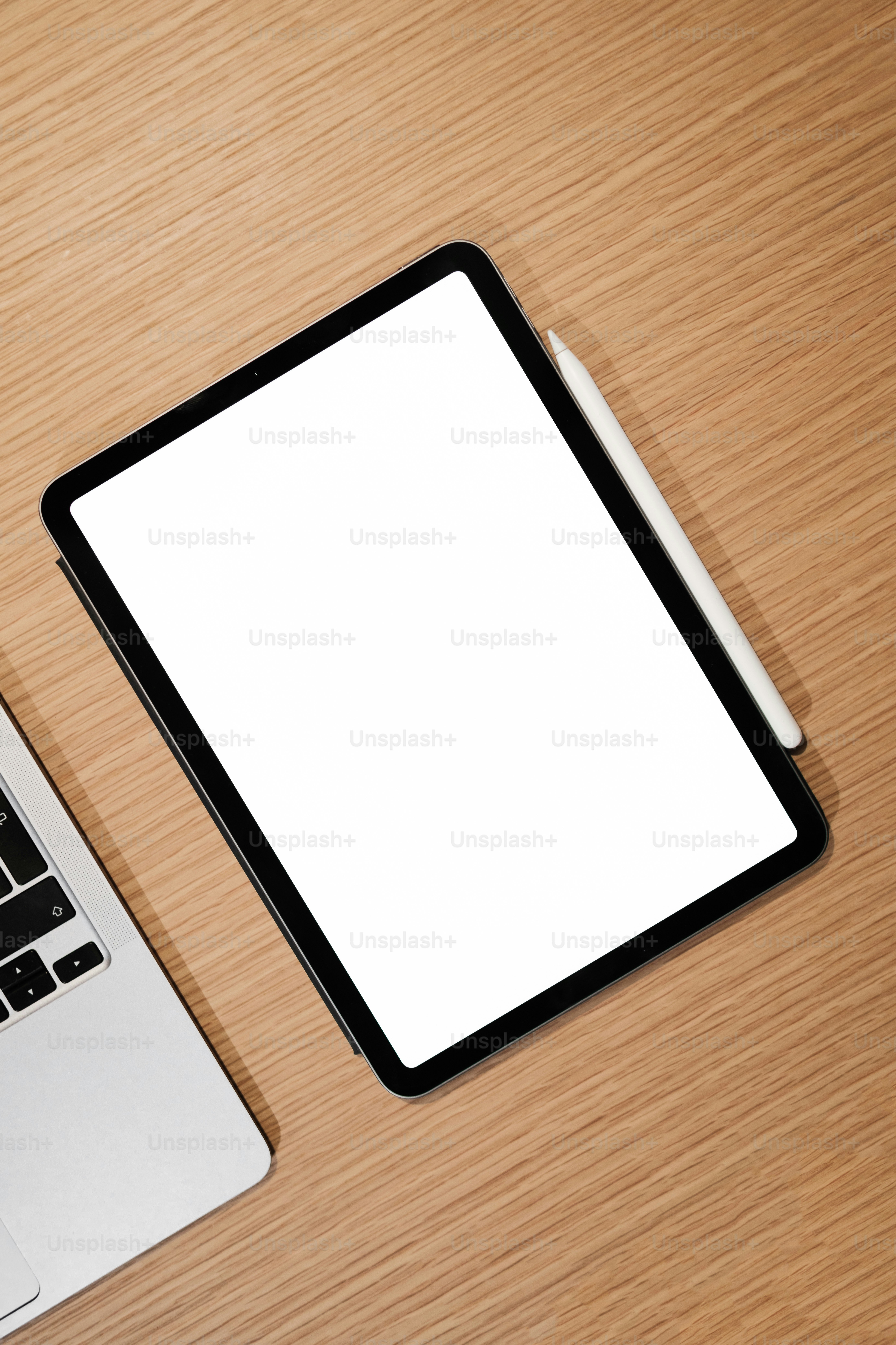 A tablet computer sitting on top of a white table photo – Ipad mockup ...