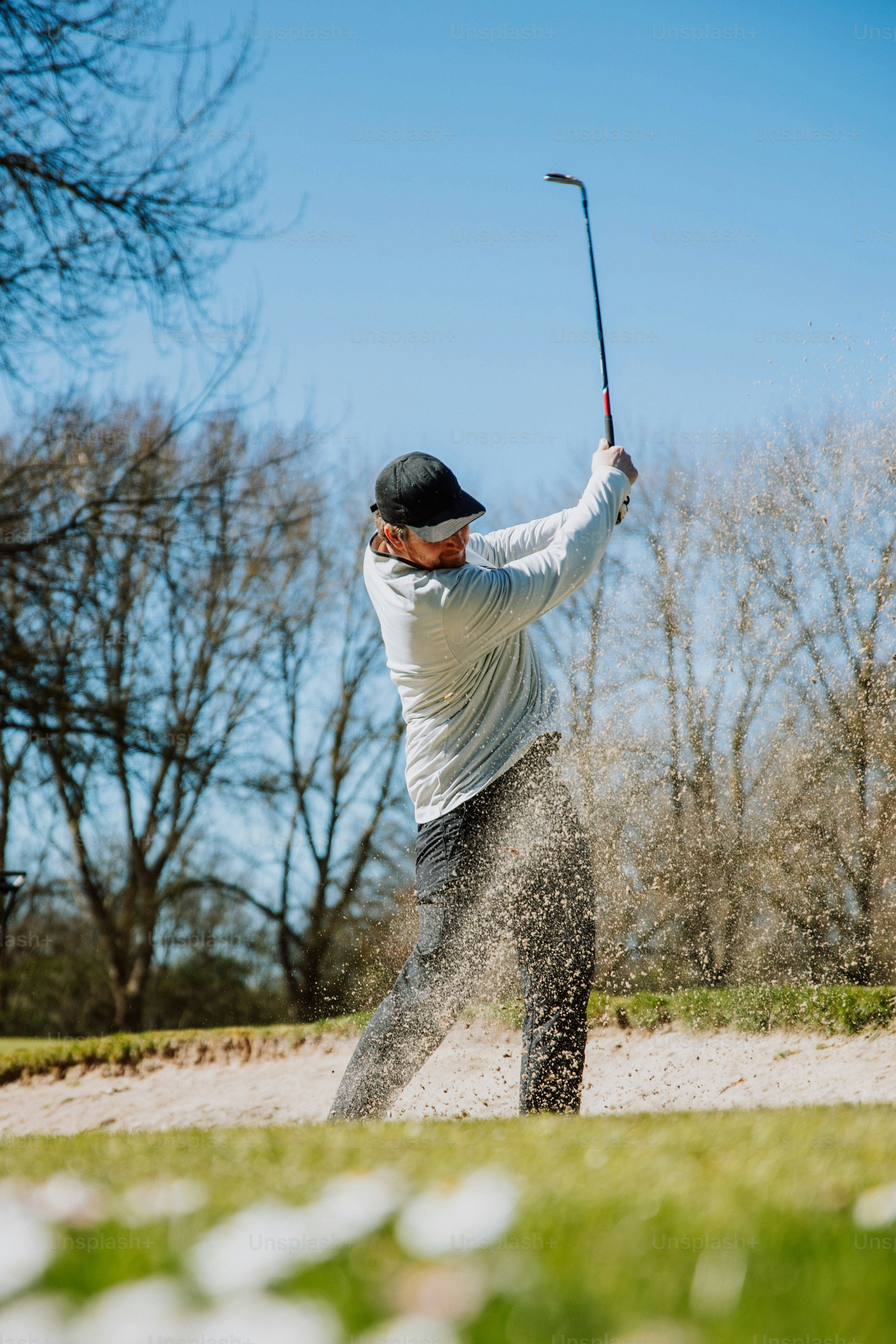 A man hitting a golf ball with a golf club photo – Golf Image on Unsplash