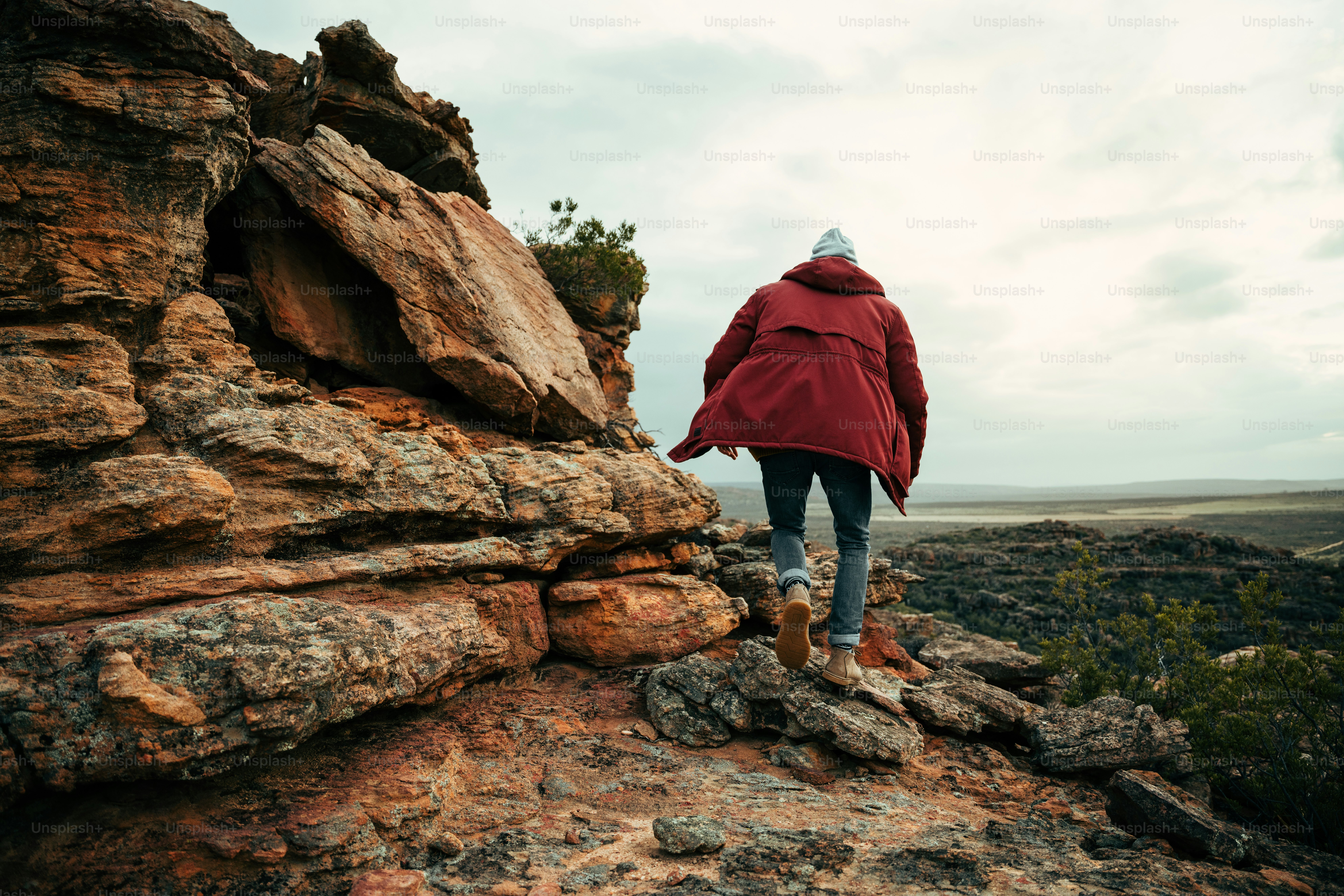 Caucasian male hiker walking through mountain hiking with friends ...