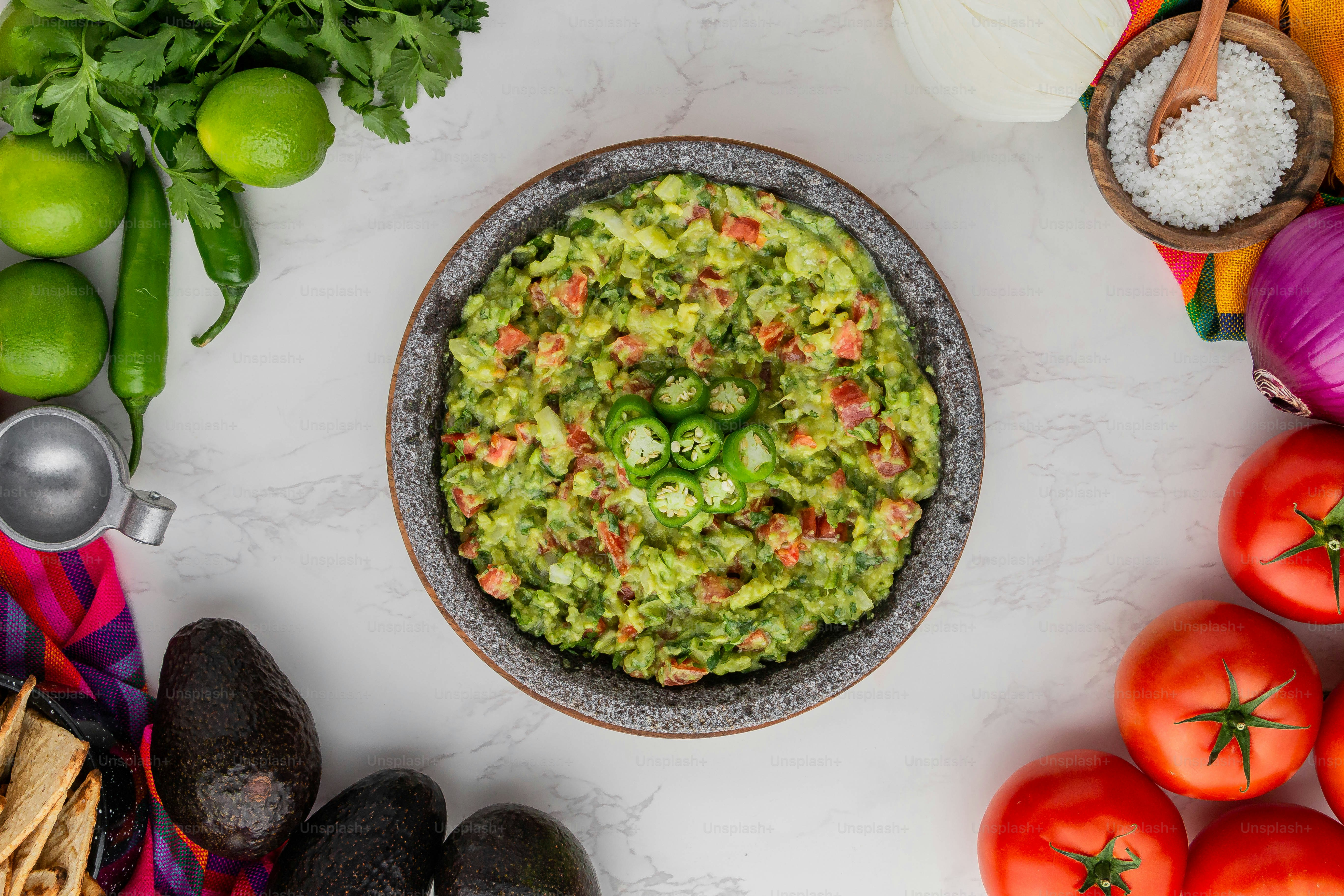 A bowl of guacamole surrounded by vegetables photo – Guacamole Image on ...