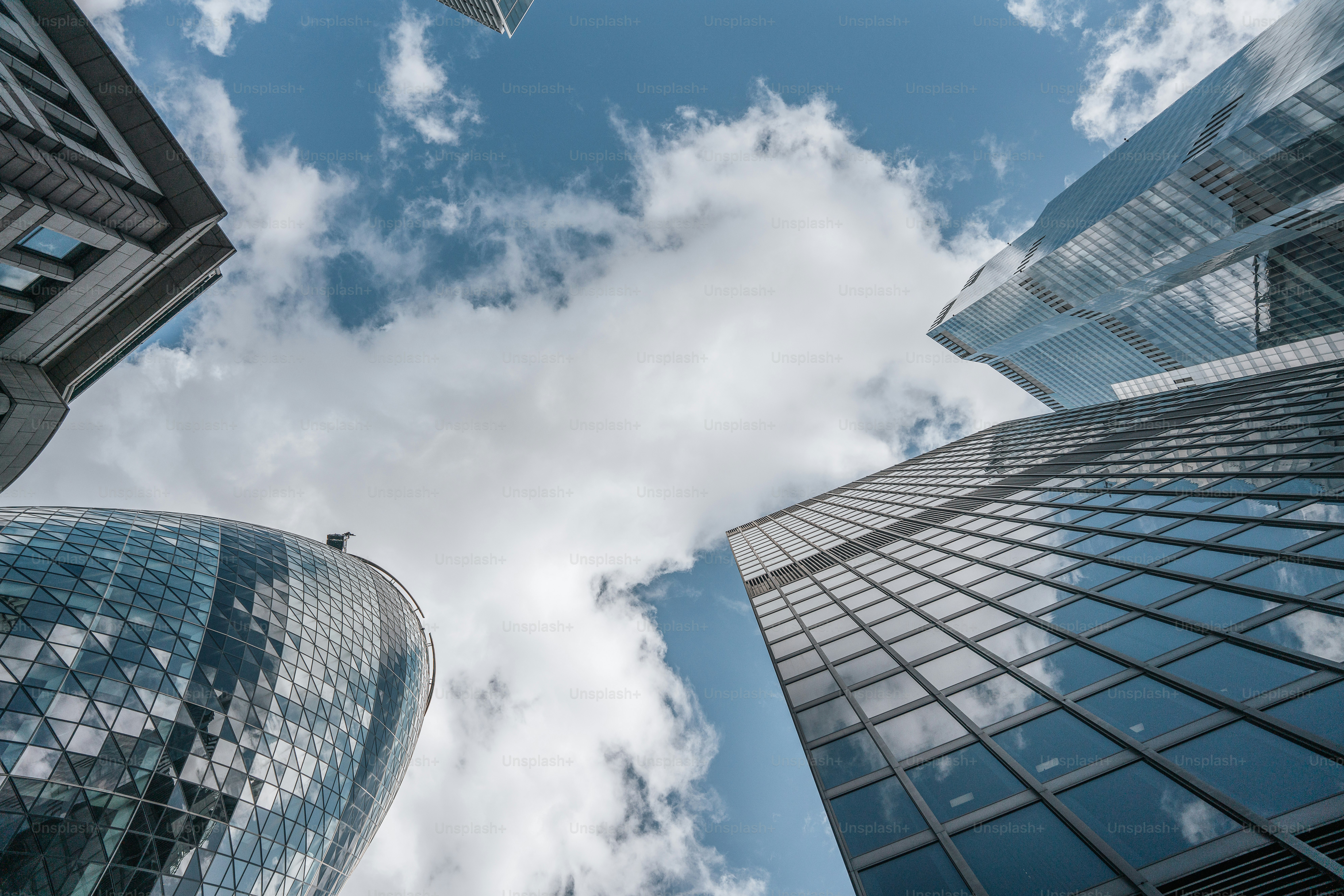 Looking up at tall buildings in a city photo – City Image on Unsplash