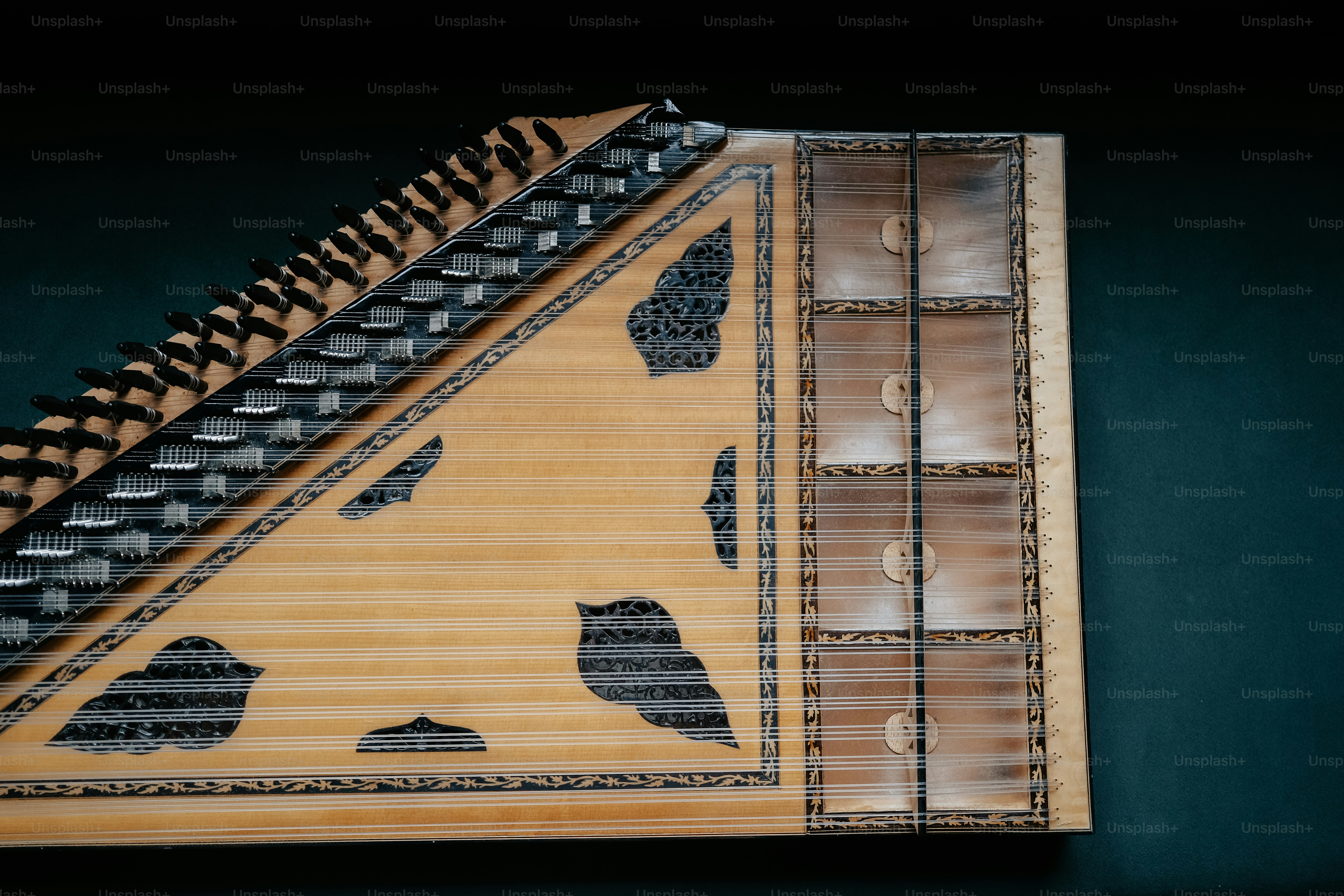 A close up of a musical instrument on a table photo – Zither Image on ...
