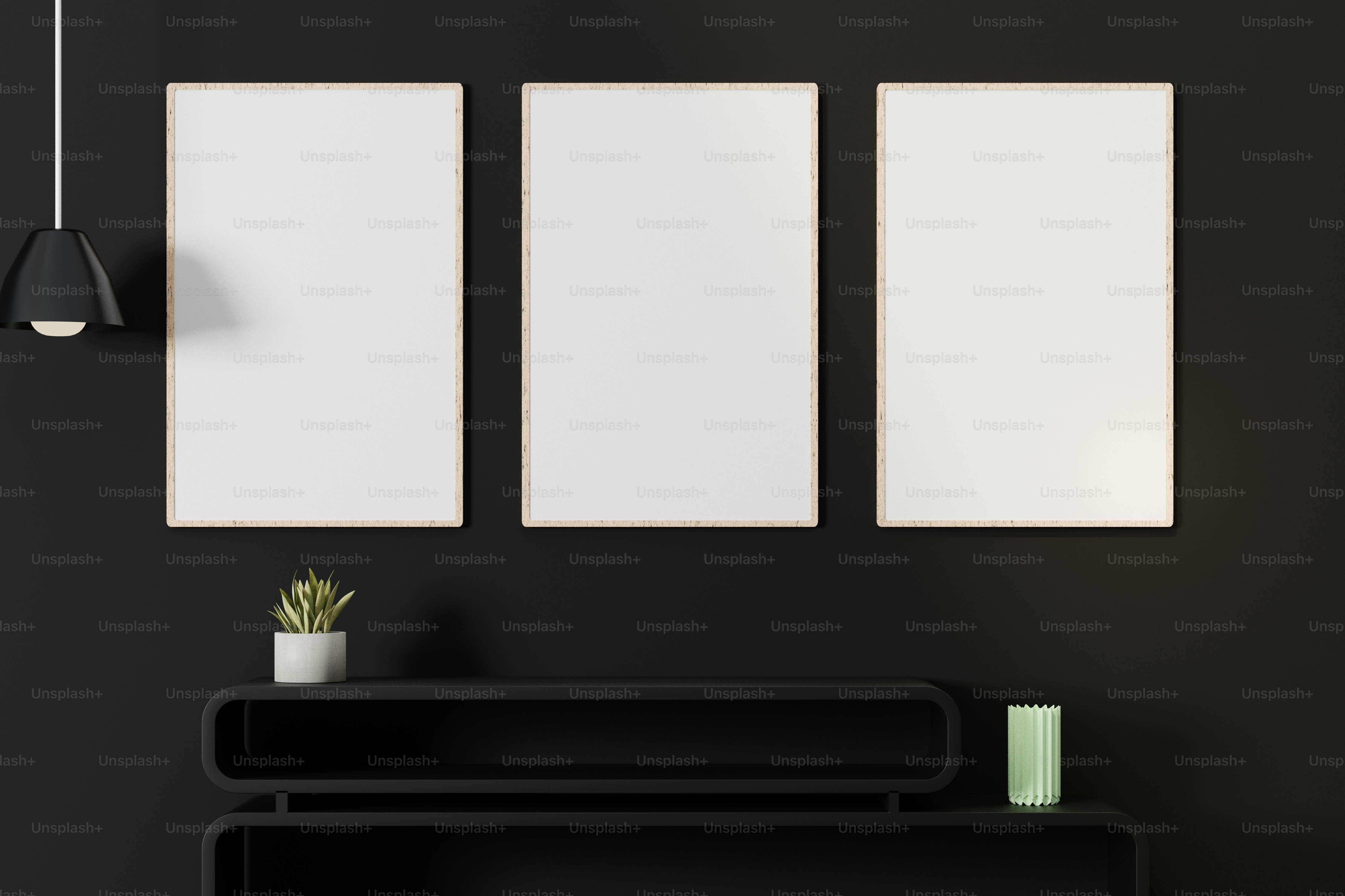 A black room with three white frames on the wall photo – Frame Image on ...