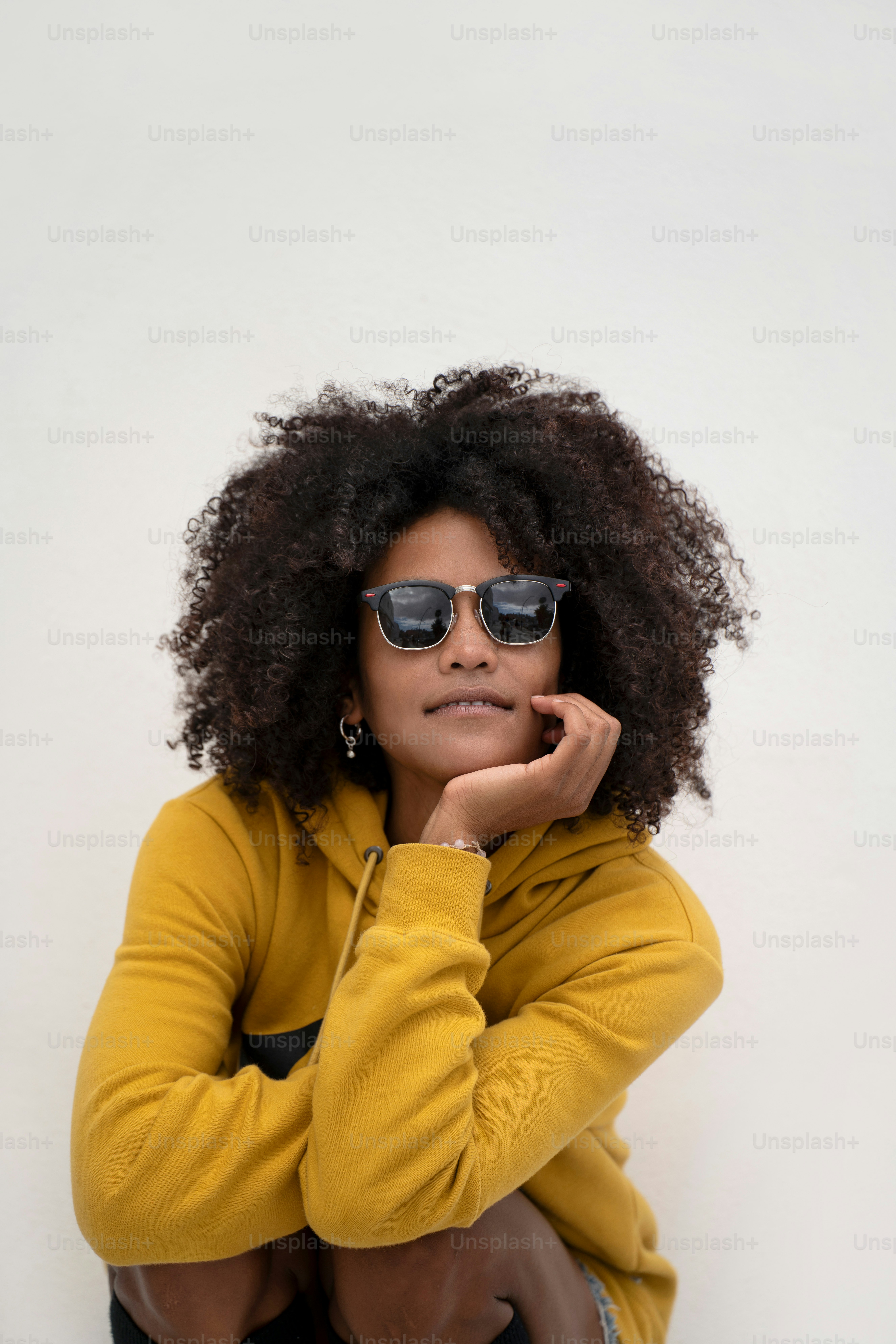 Portrait of fashionable young woman with afro hairstyle. Hipster style ...