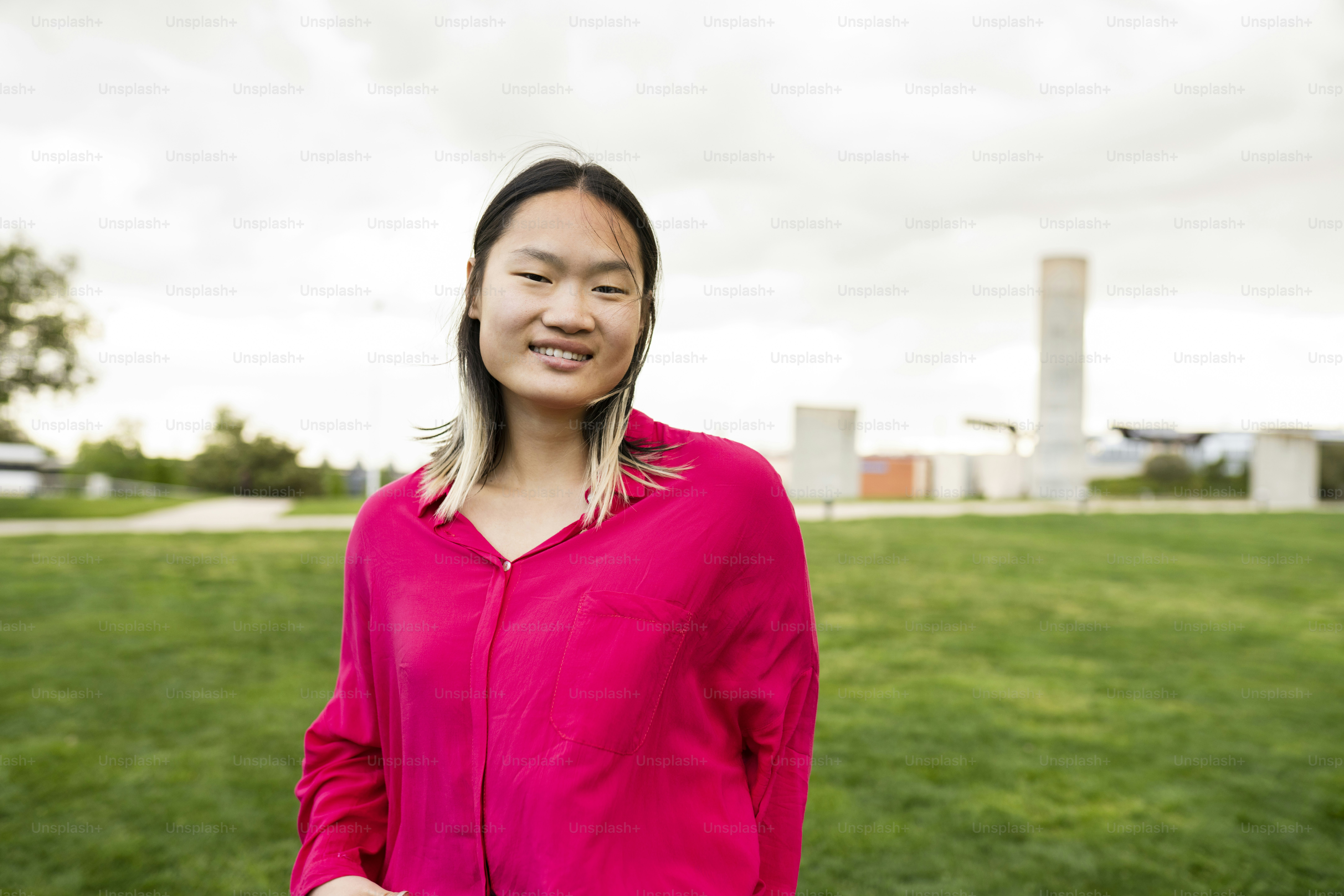 Portrait of pretty young asian woman smiling outdoors, female student ...