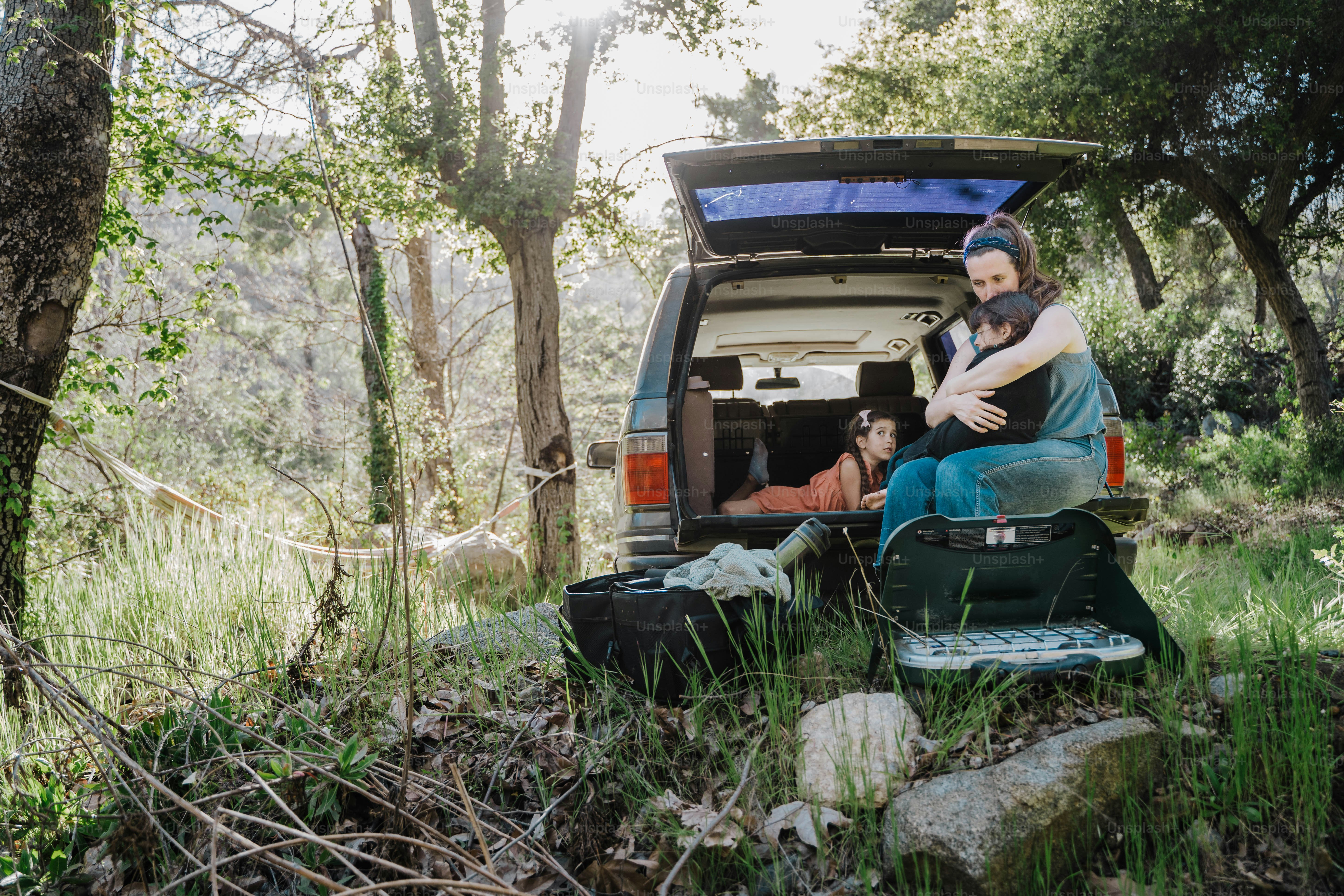 A couple of people sitting in the back of a van photo – Ensenada Image ...