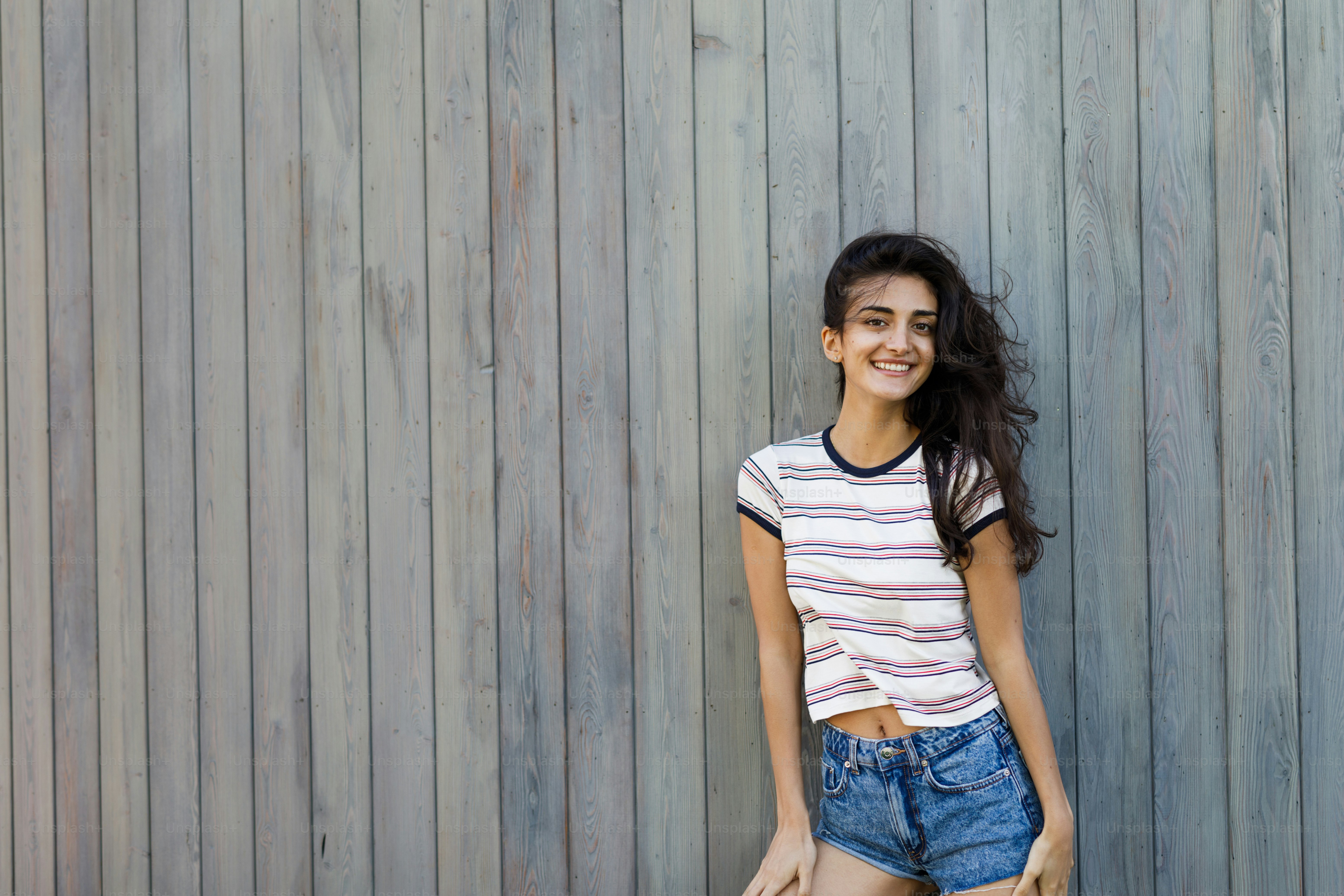 Beautiful brunette woman posing outdoors, looking at camera photo ...