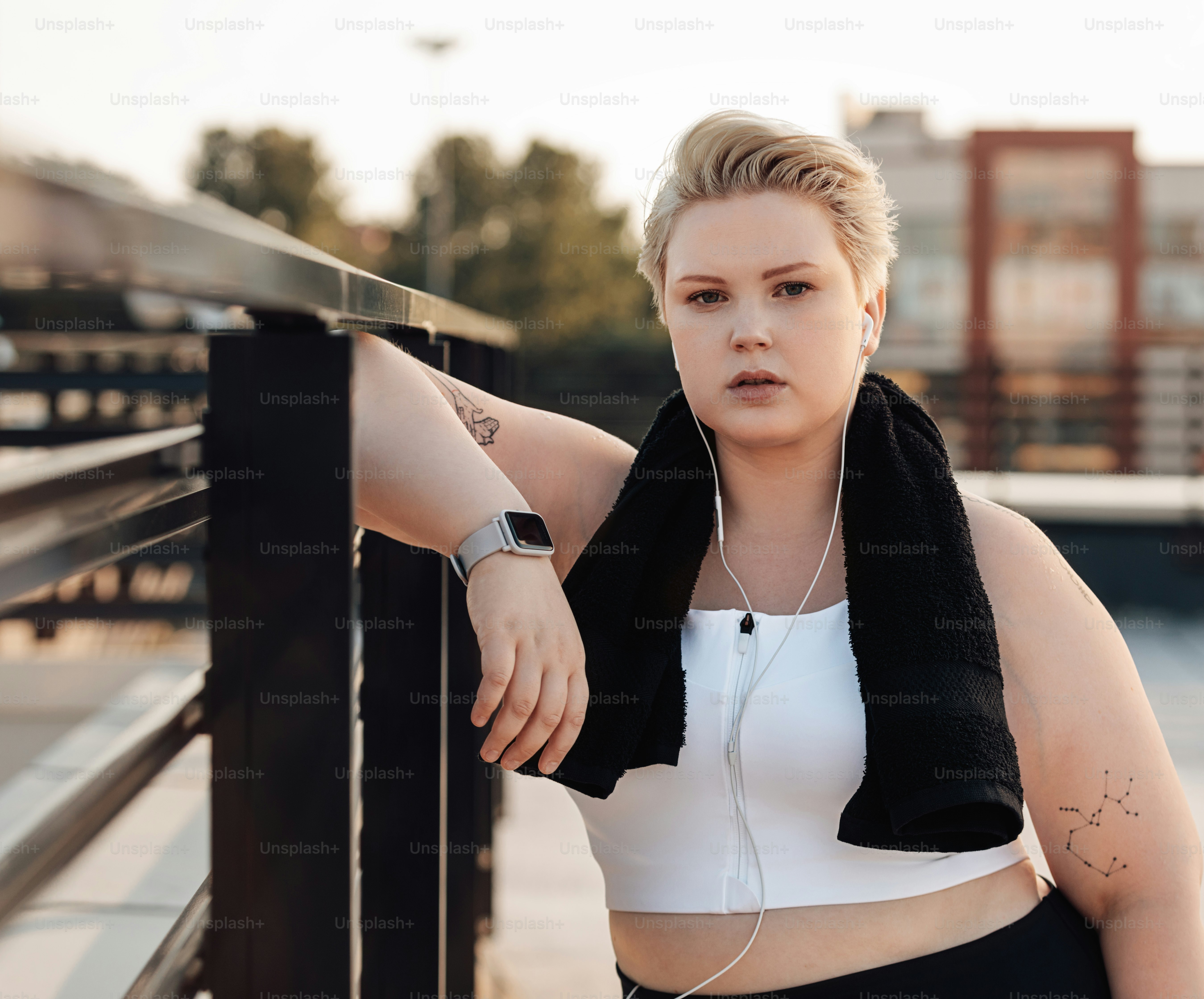 Portrait of a curvy caucasian woman leaning on a railing relaxing photo ...