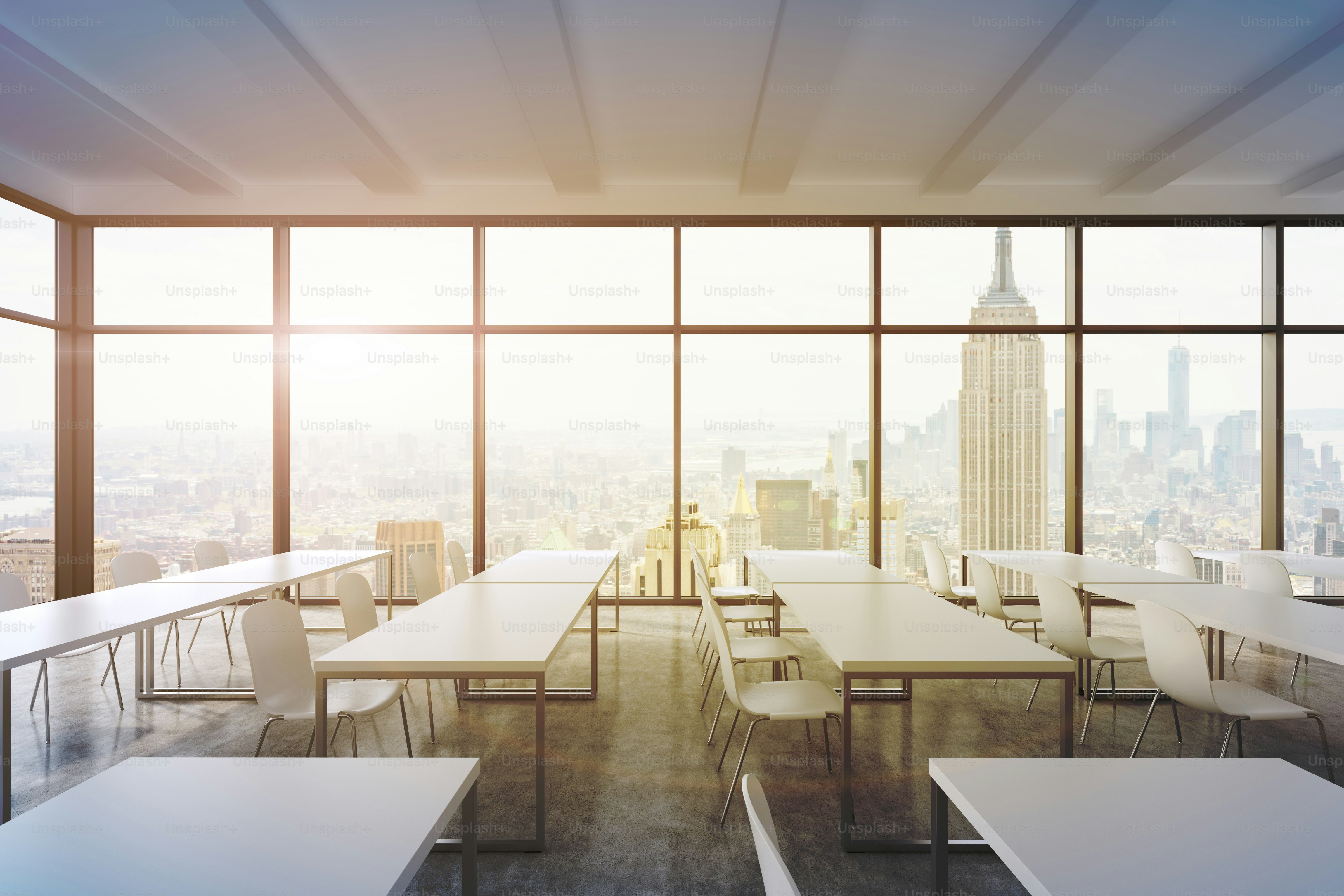 A modern panoramic classroom with New York view. White tables and white ...