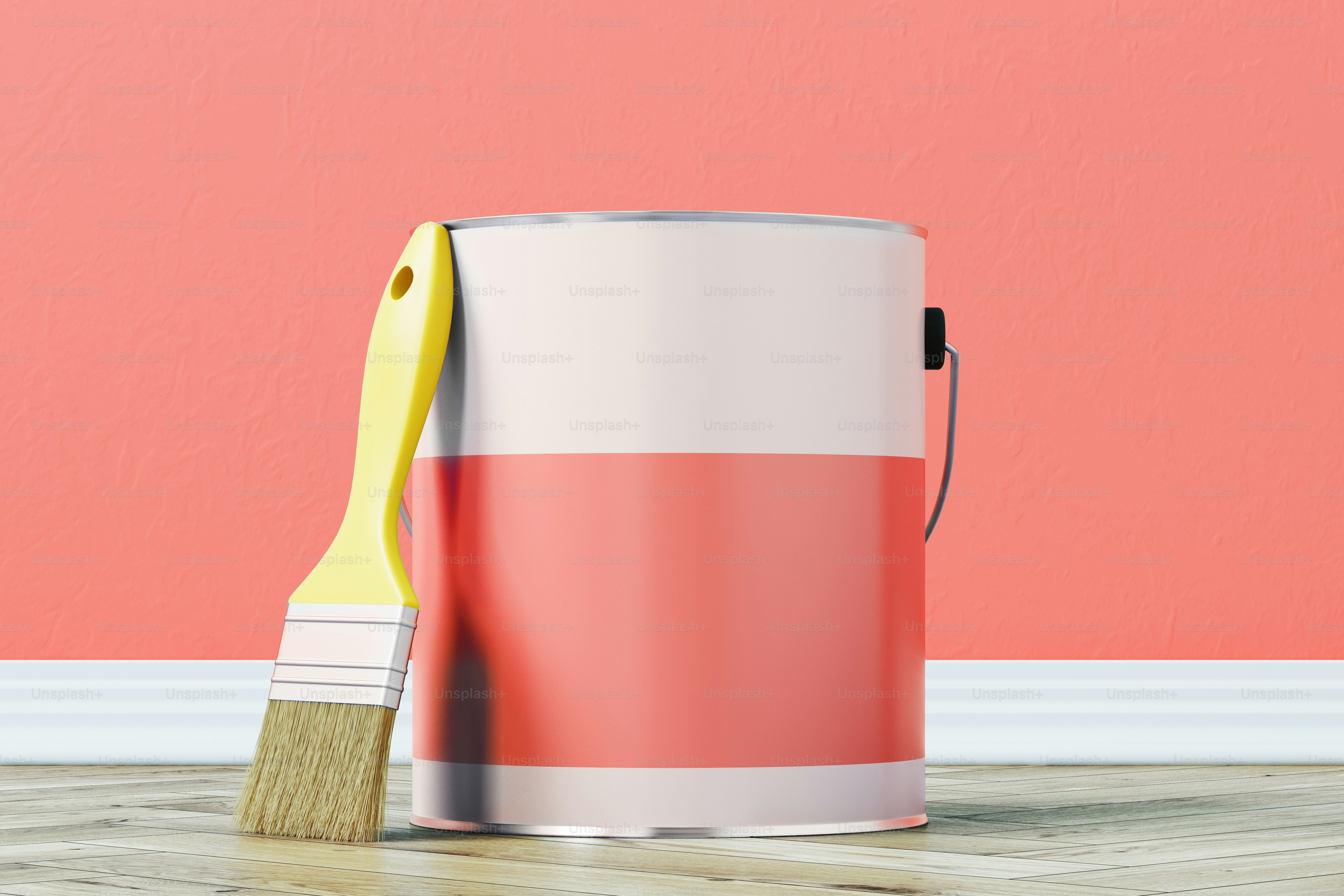 Close up of a red paint bucket standing on a wooden floor against a red ...