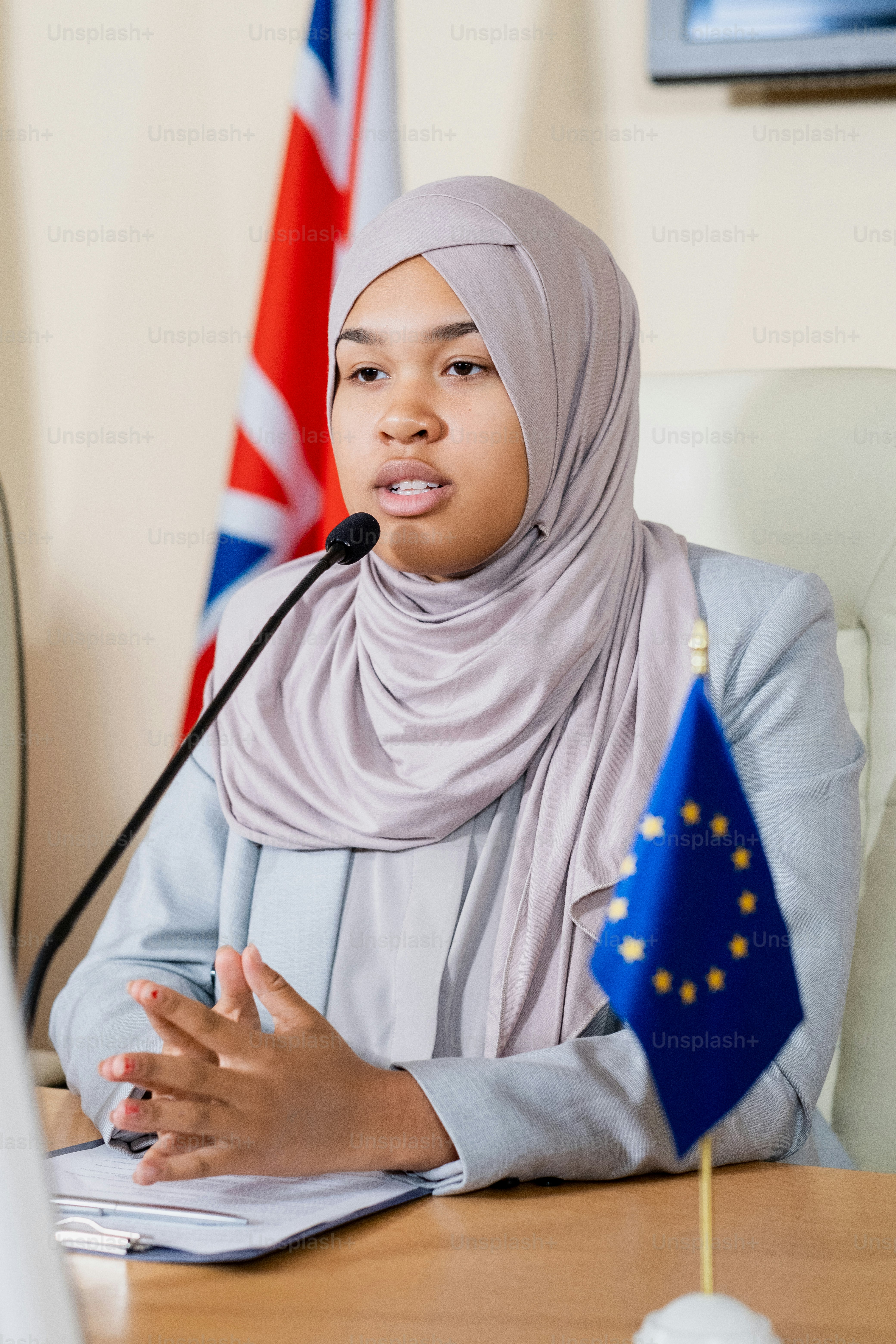 Confident muslim representative of European Union in hijab touching ...