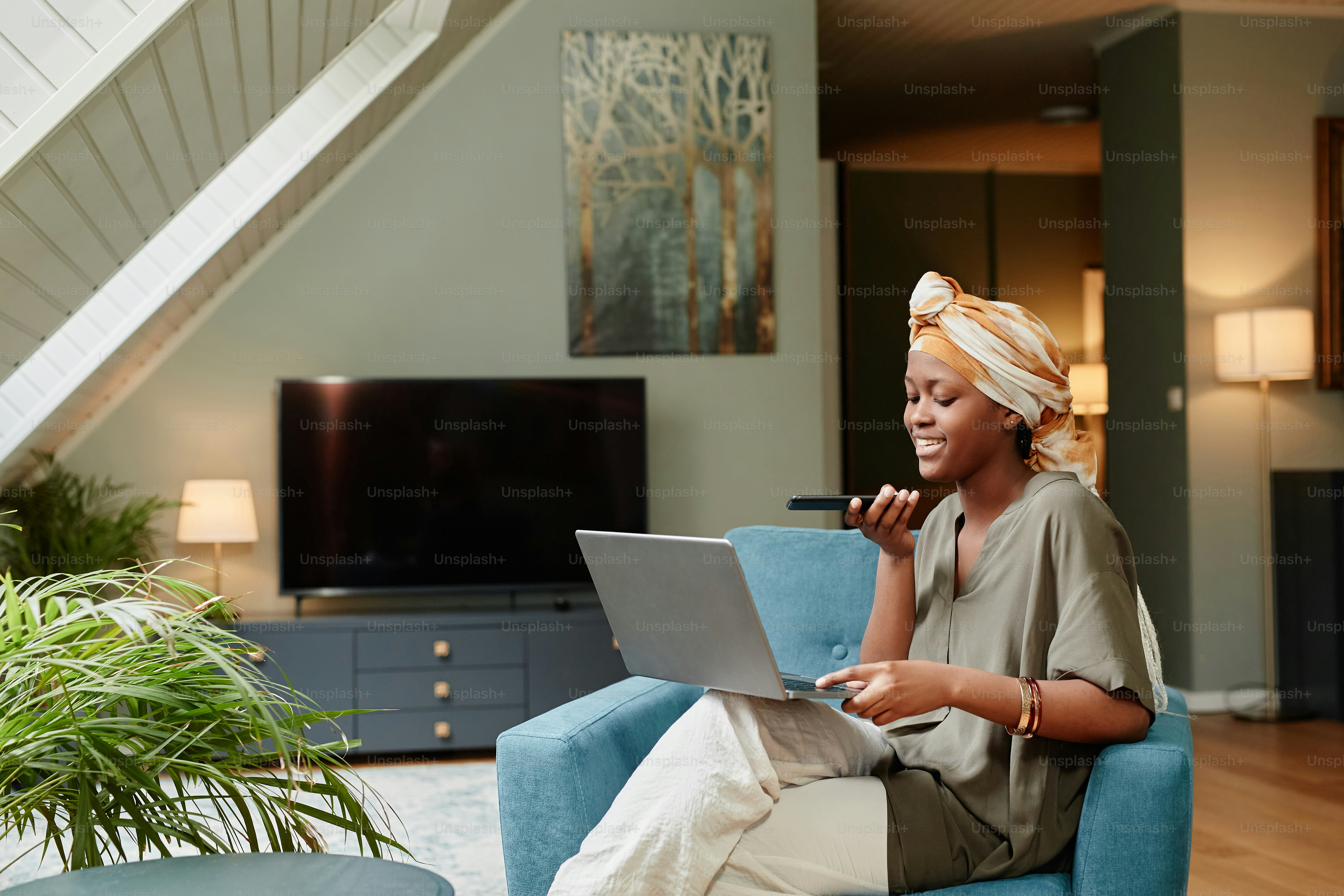 Portrait of smiling African-American businesswoman working at home and ...