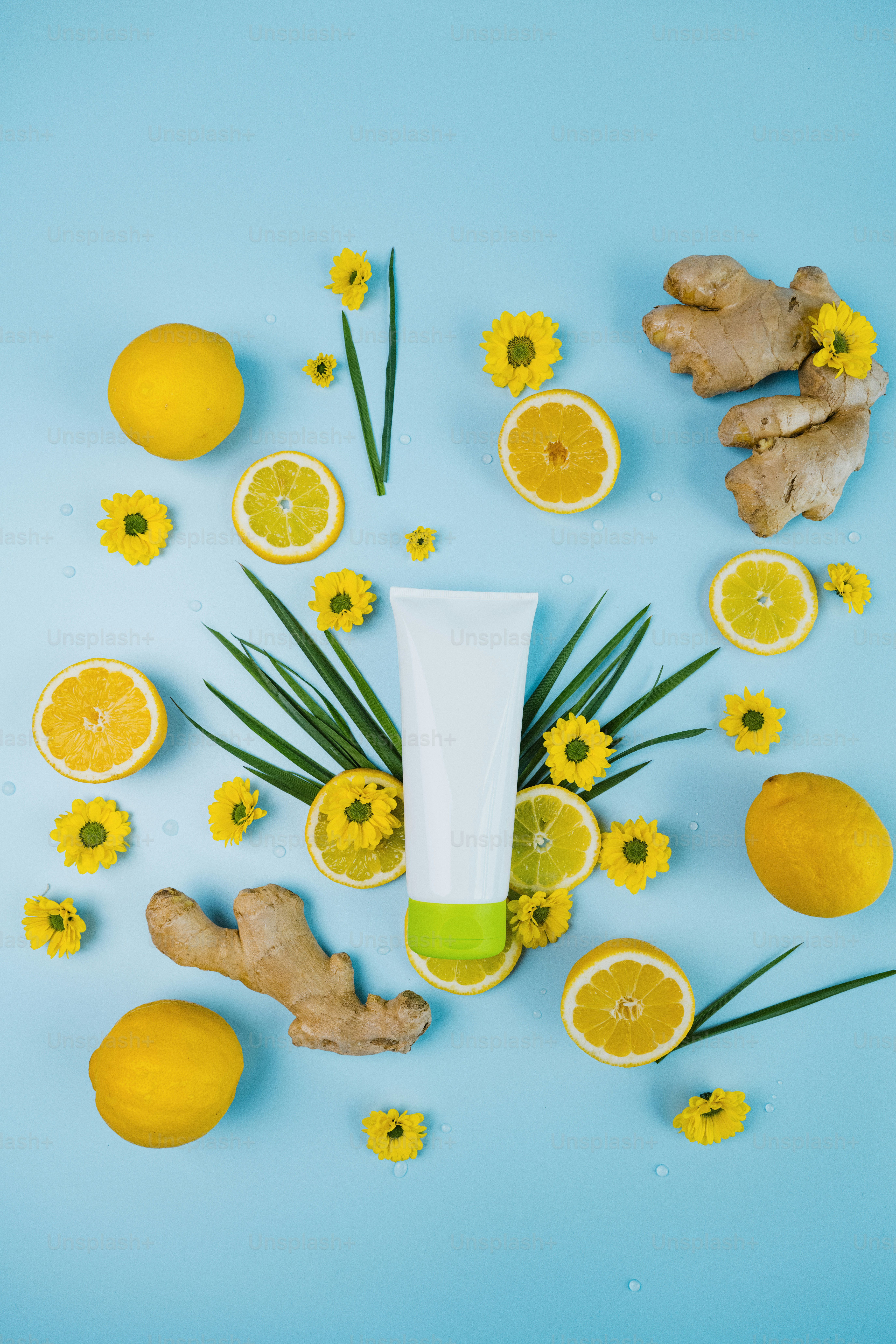 A tube of toothpaste surrounded by lemons and ginger photo – Mockup ...