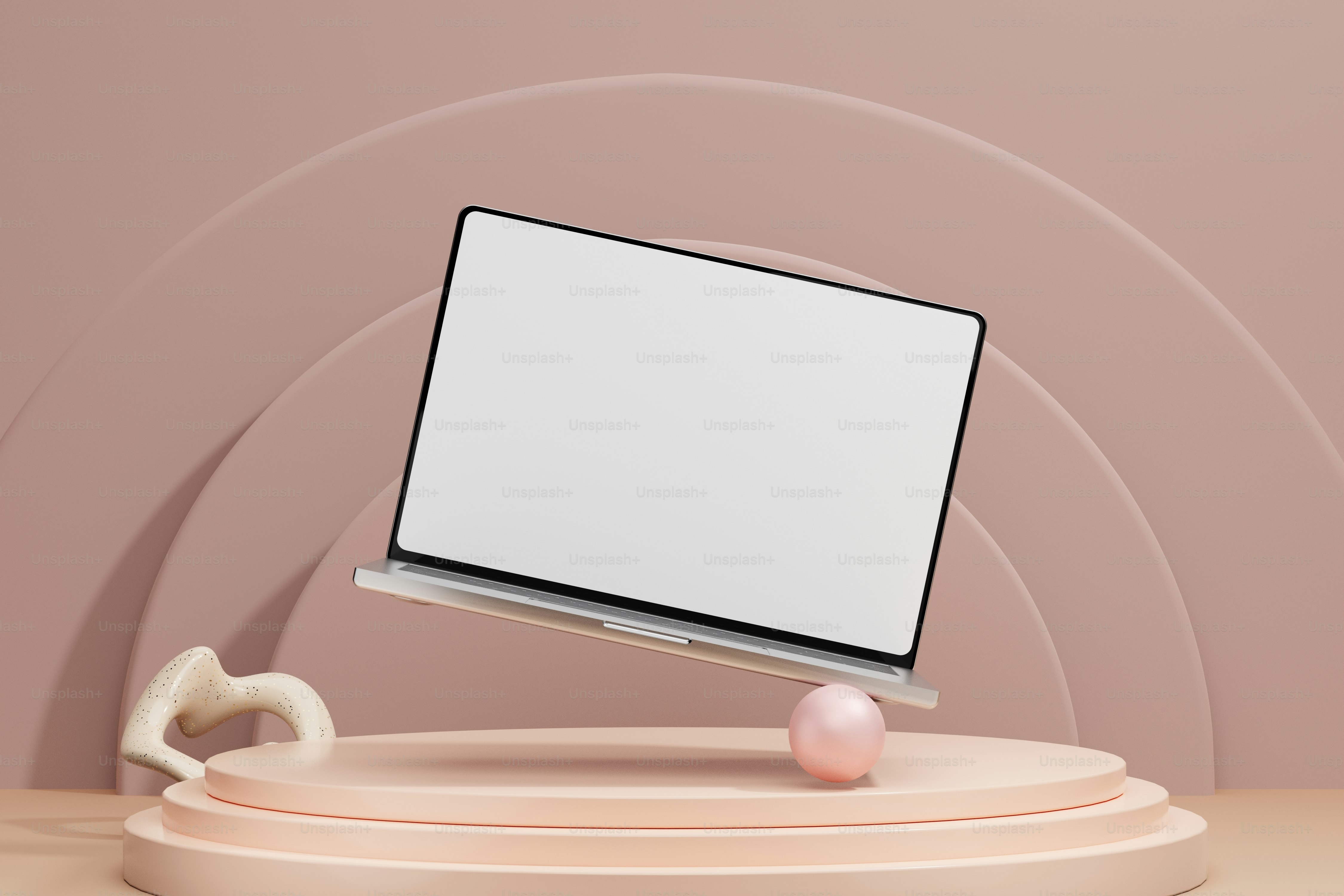 A computer monitor sitting on top of a table photo – Laptop Image on ...