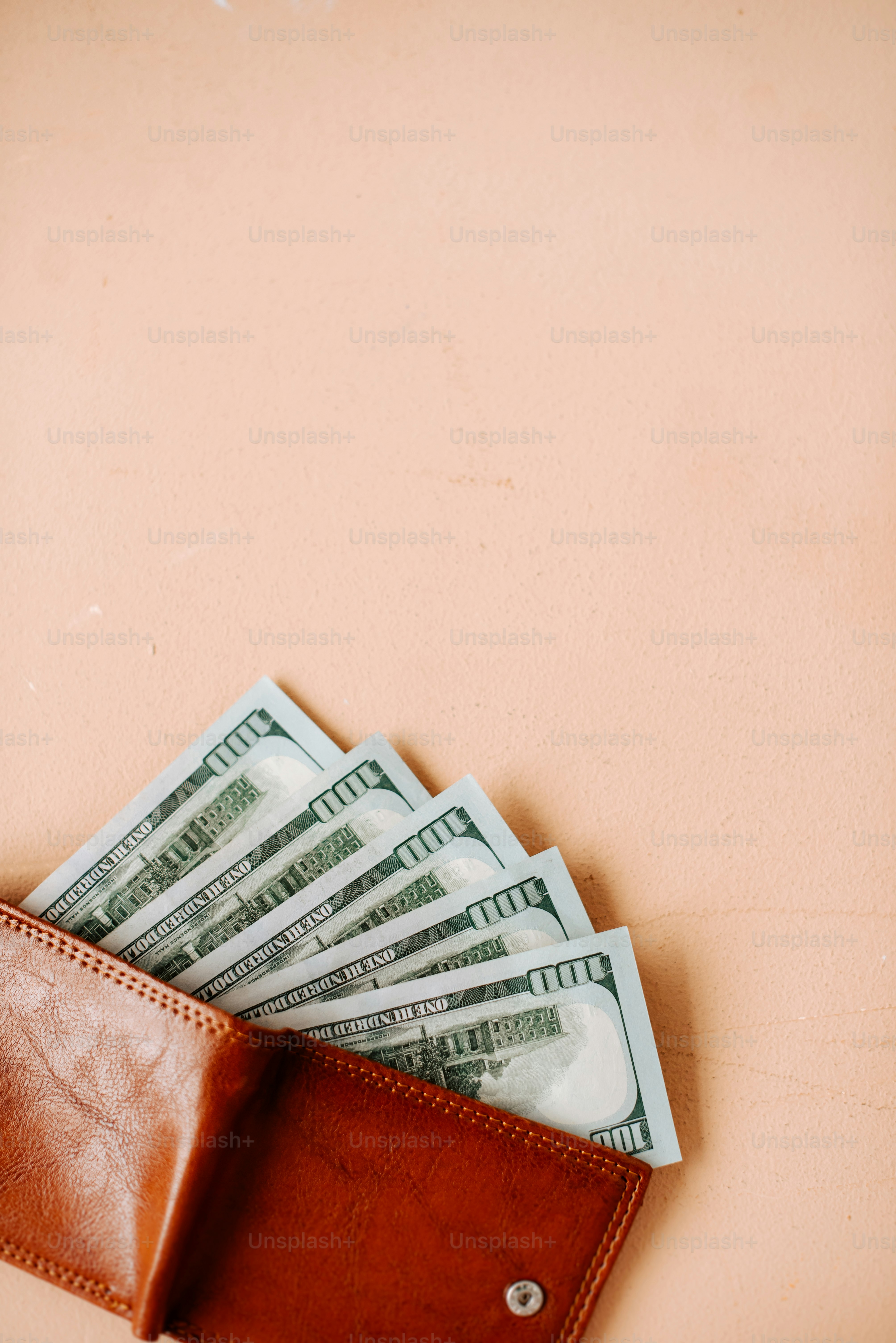 A wallet with money sticking out of it photo – Money Image on Unsplash
