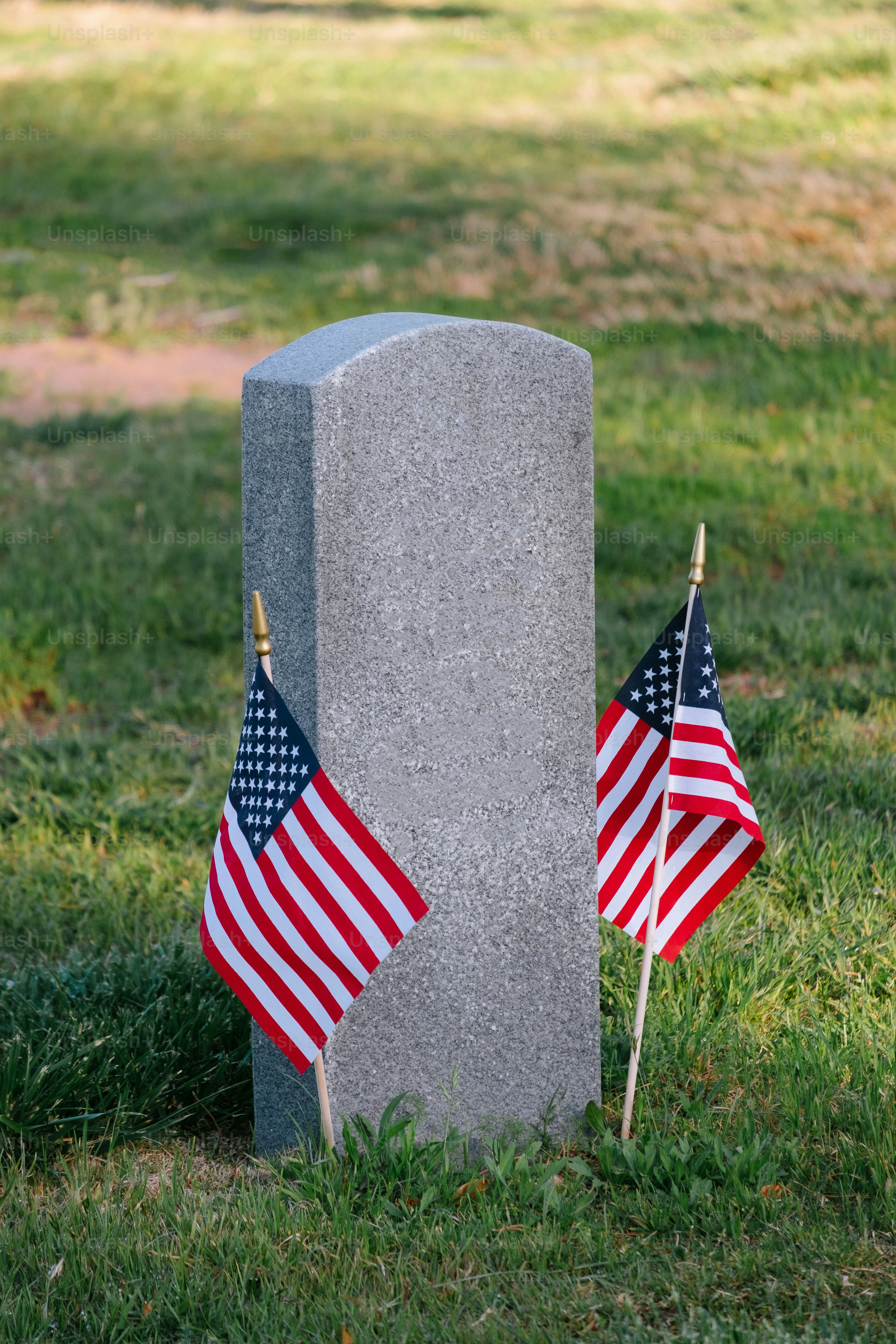 Two american flags are placed next to a grave photo – American flag ...
