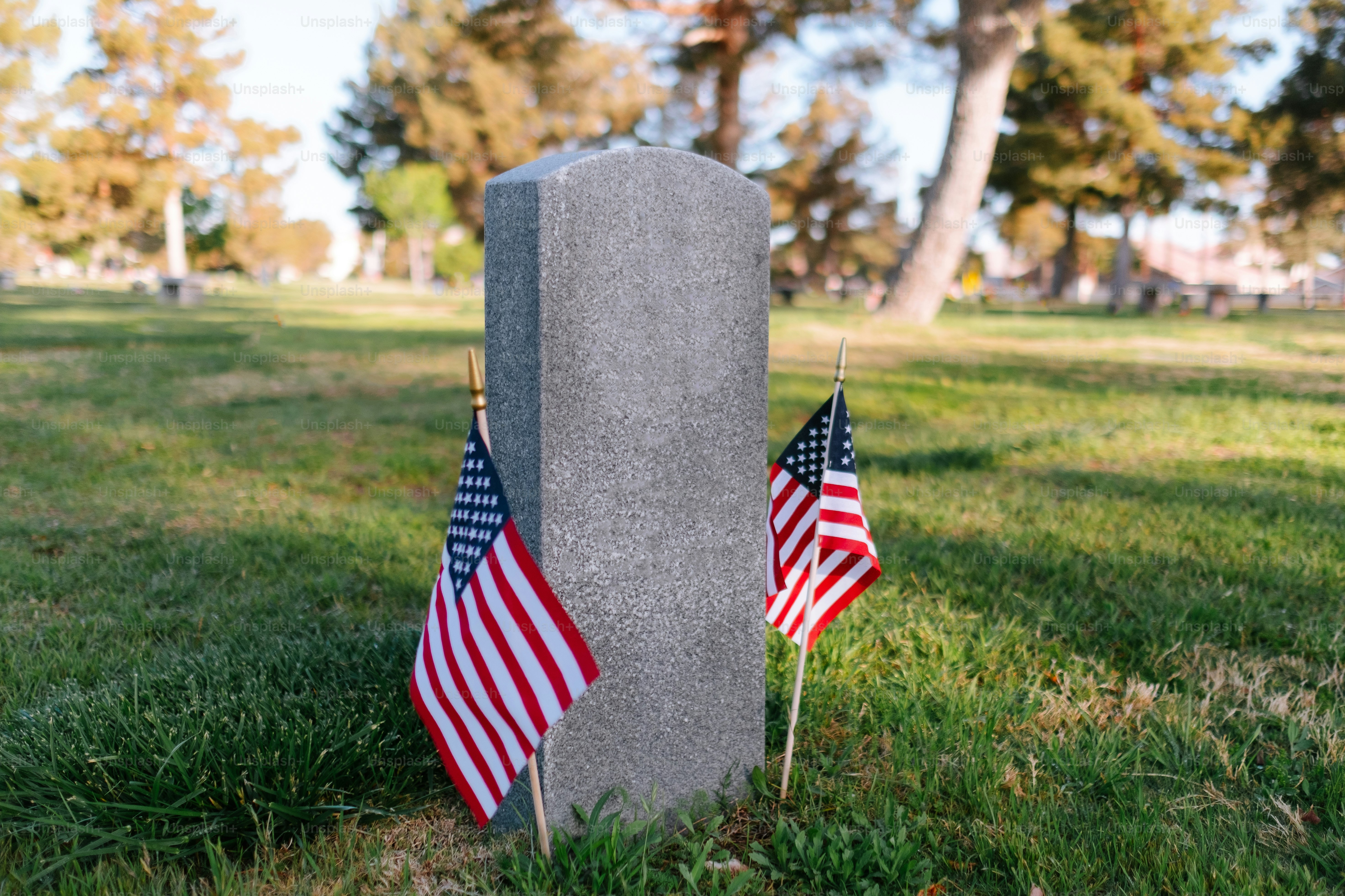 Two american flags are placed next to a grave photo – United states ...