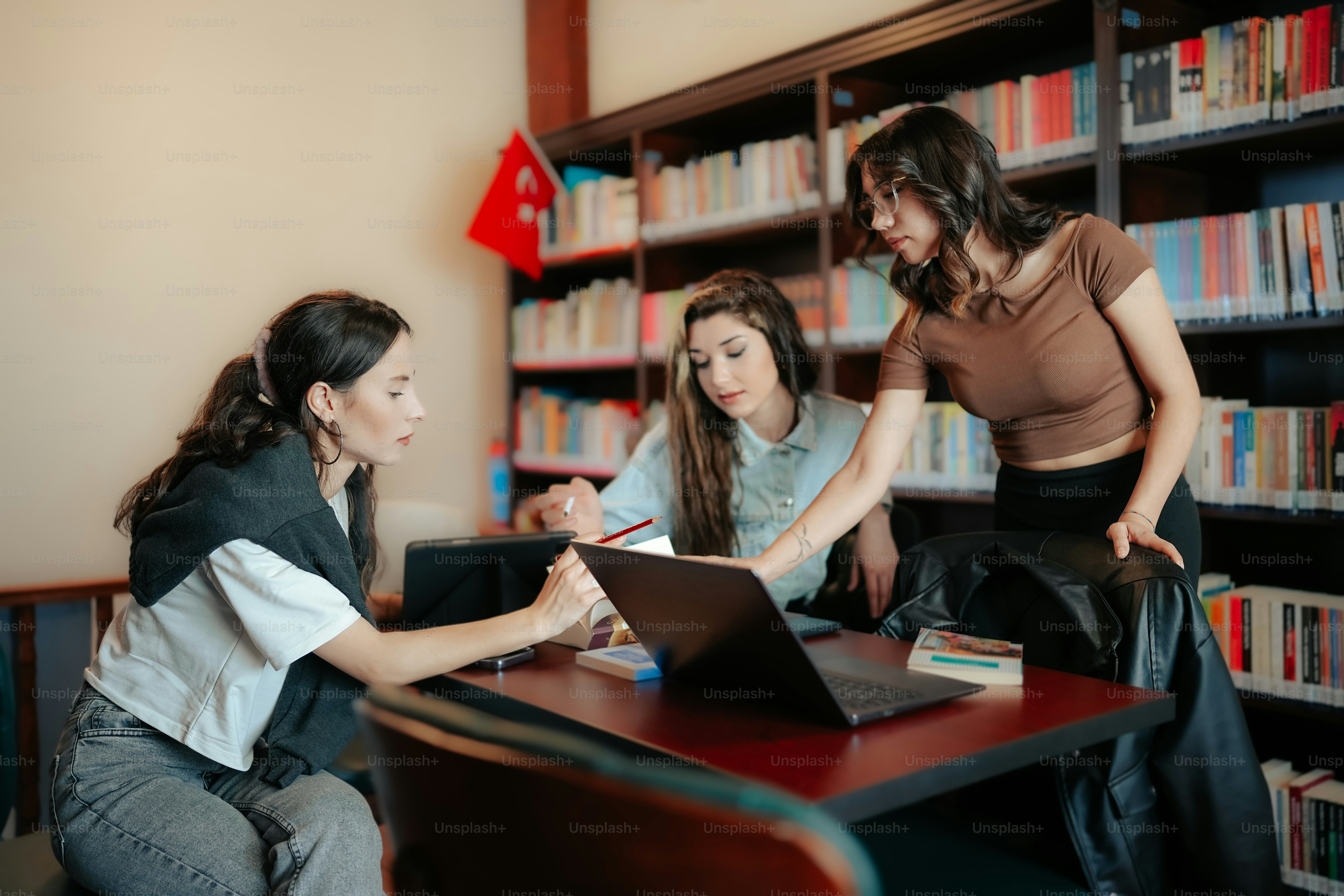 A group of women sitting around a laptop computer photo – Woman Image ...