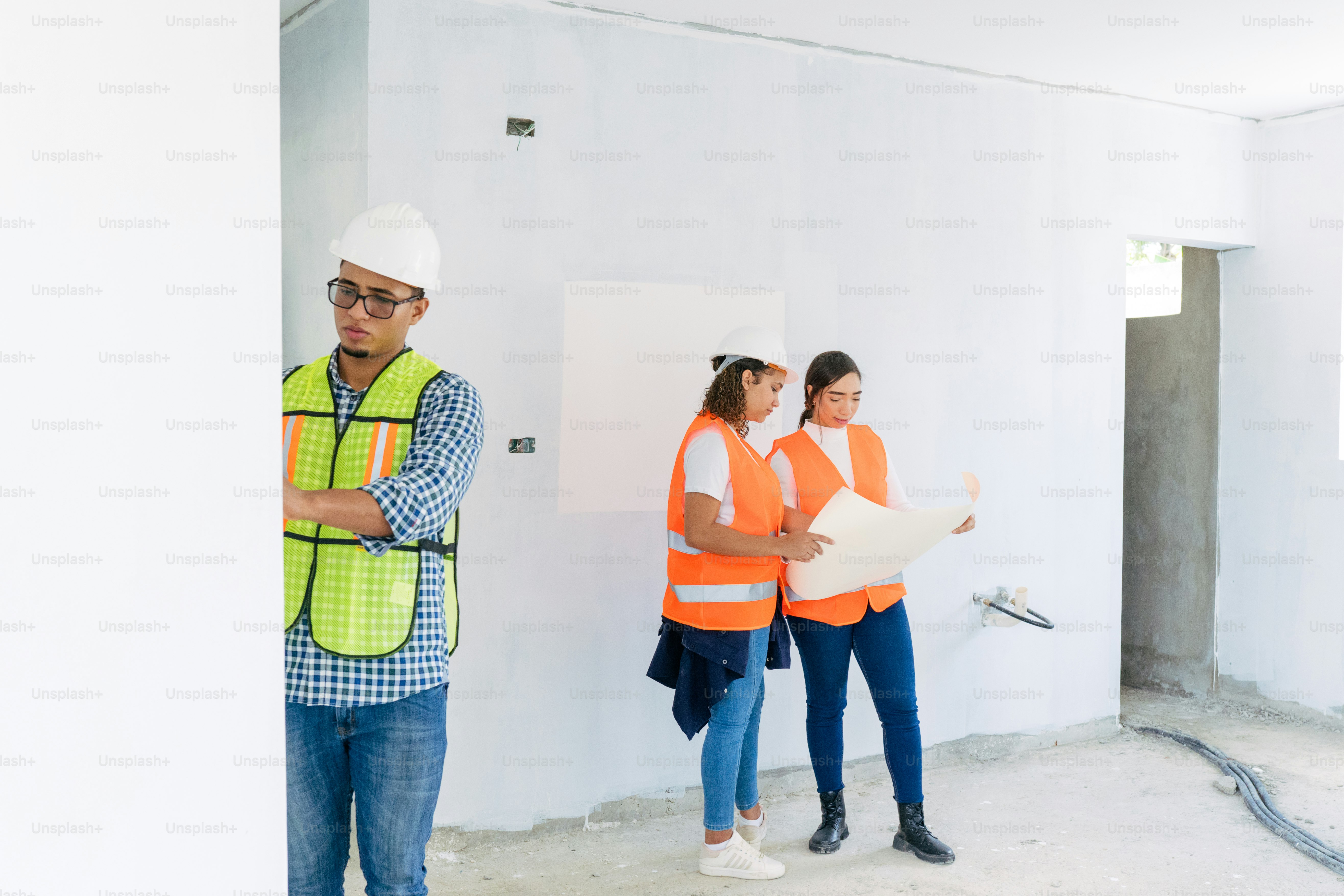 A group of people standing around a building under construction photo ...