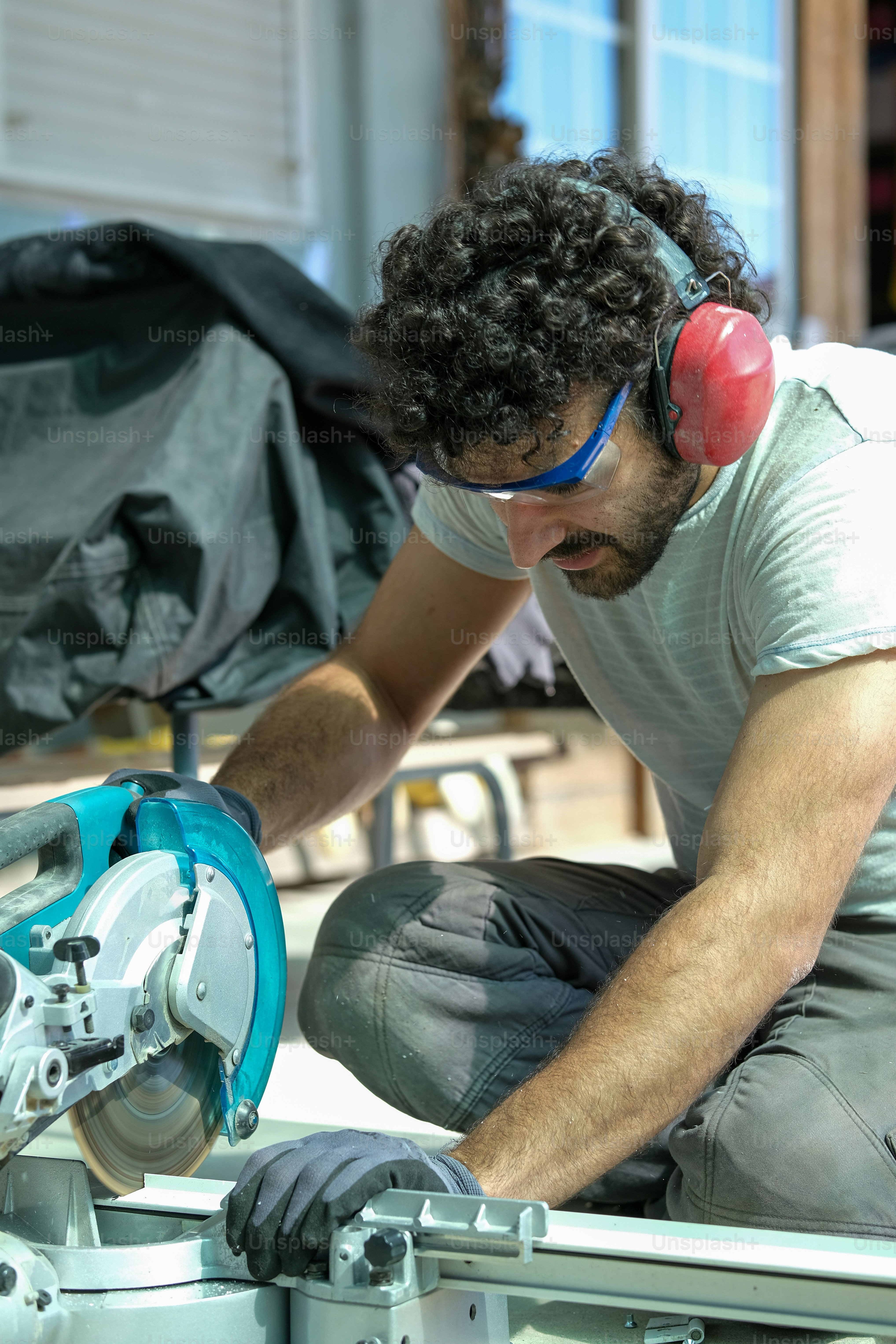 A man working on a piece of machinery photo – Construction worker Image ...