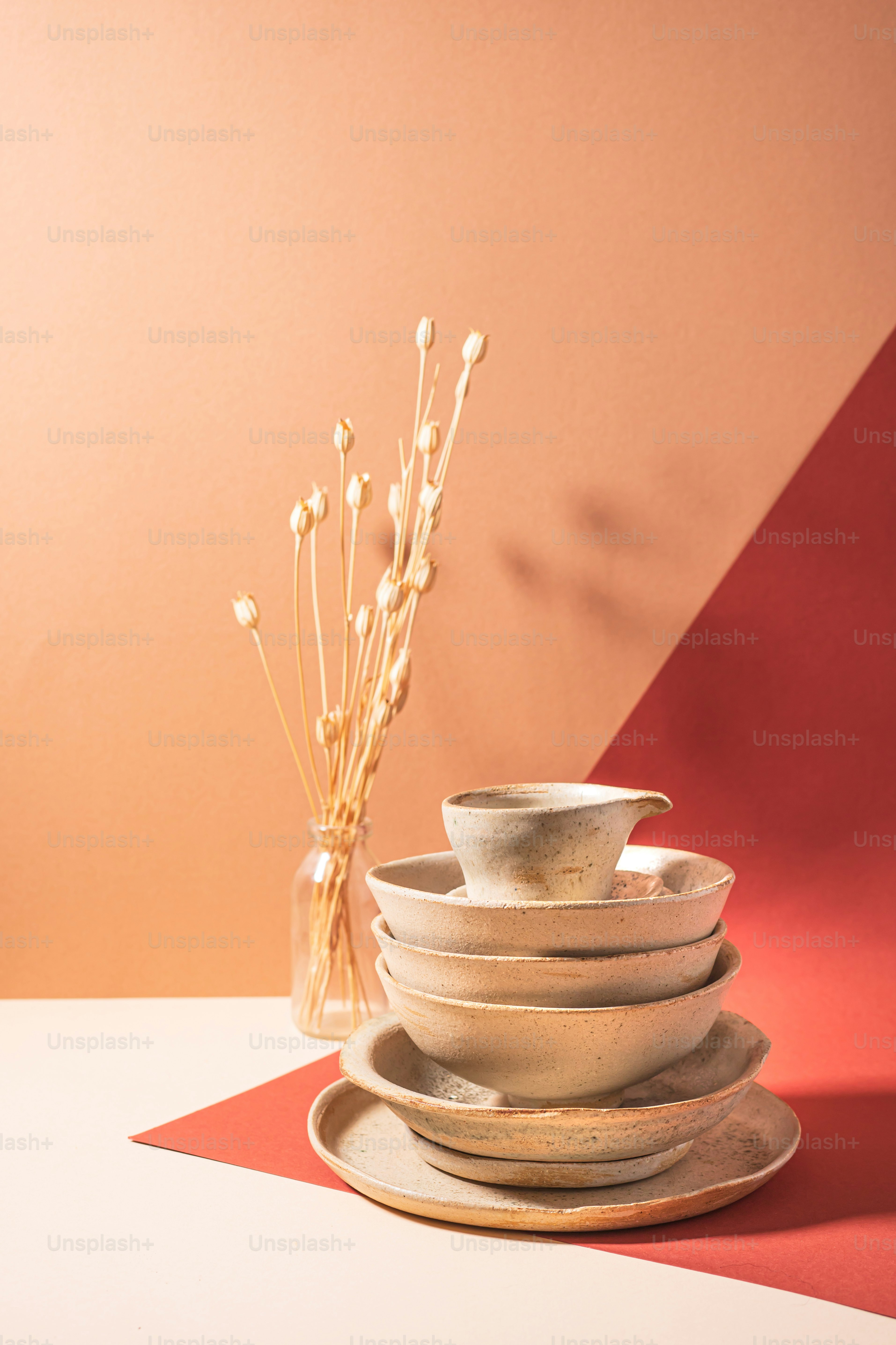 A stack of plates sitting on top of a table photo – Still life Image on ...