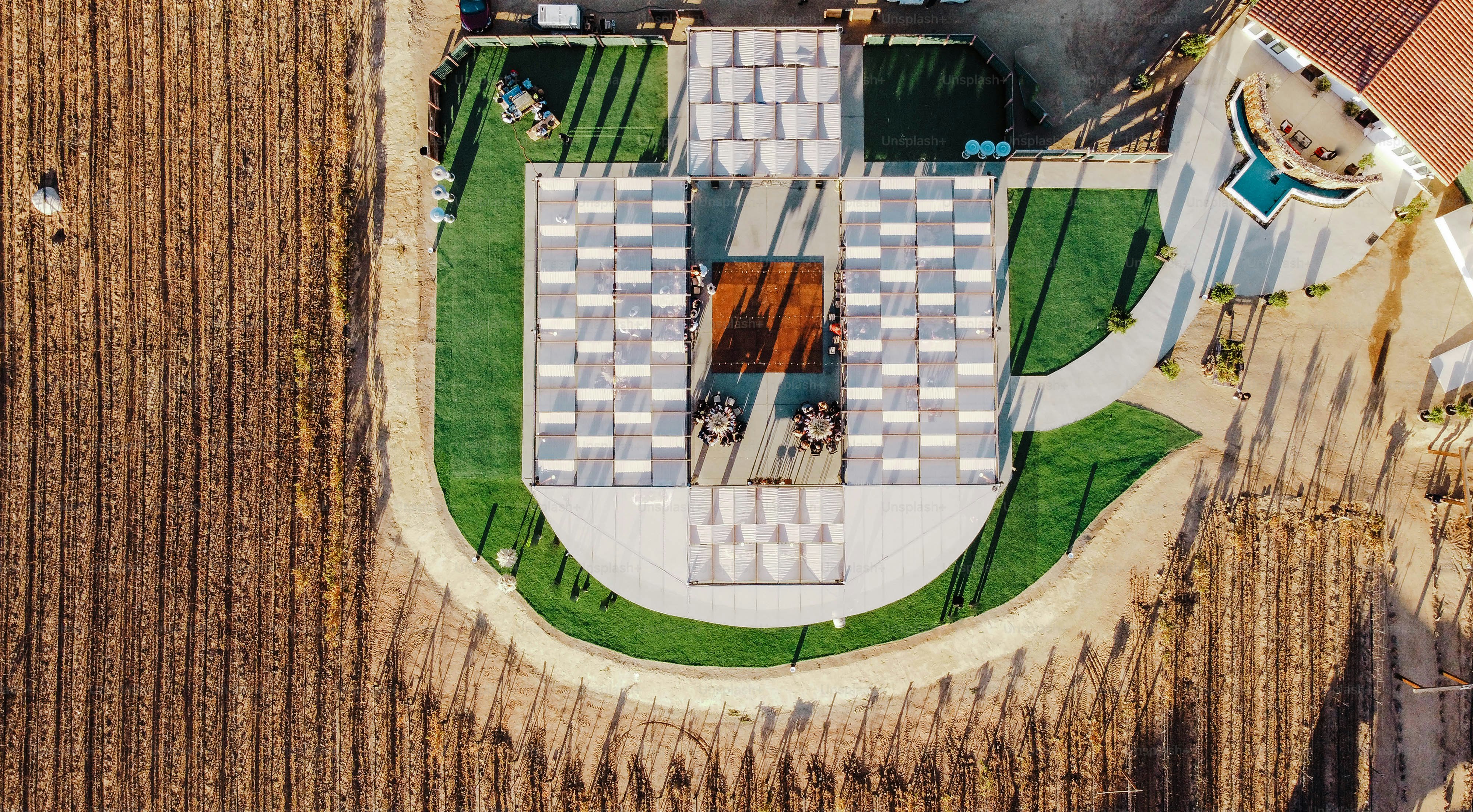 An aerial view of a farm house with a pool photo – Luxury villa Image ...