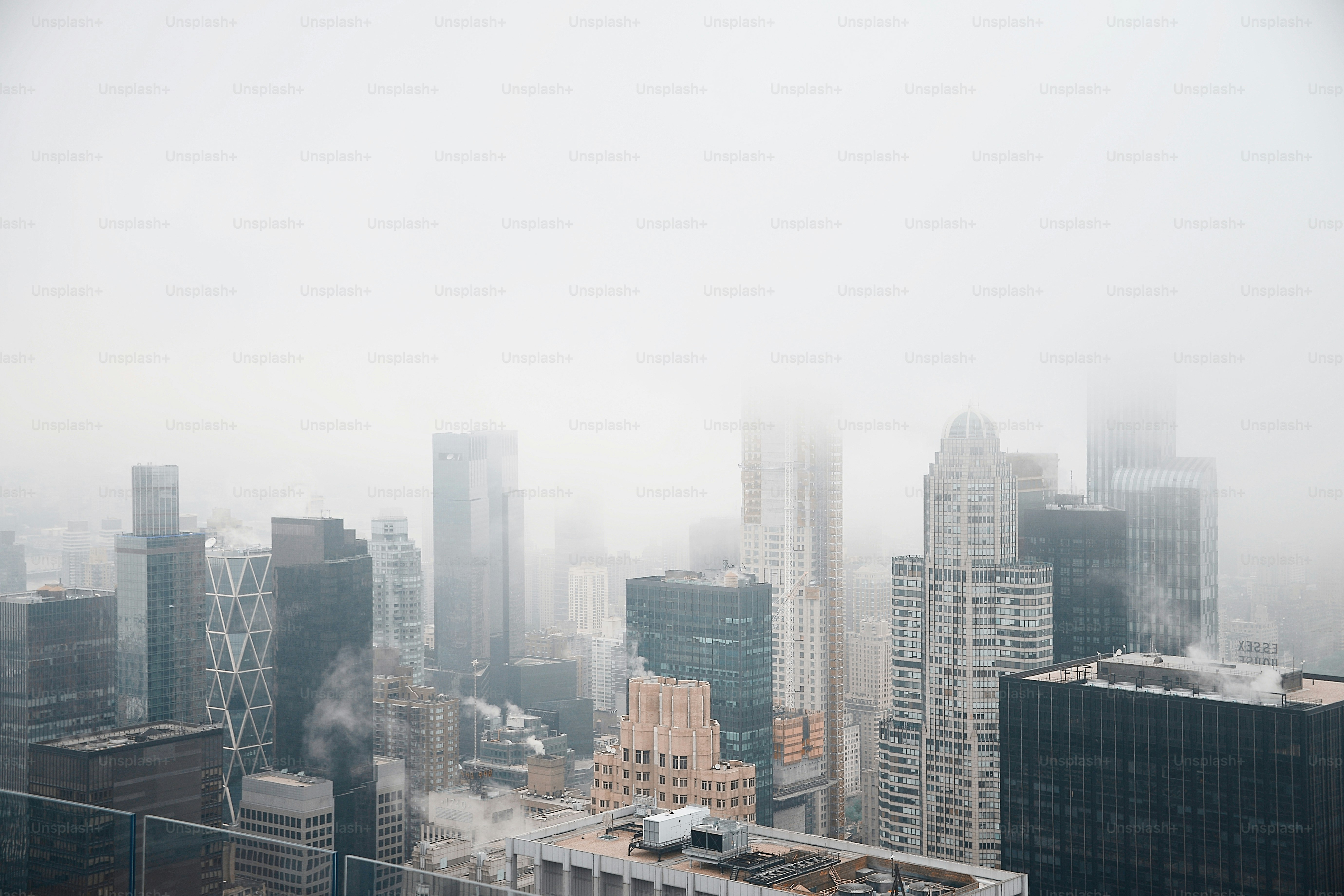 A foggy view of a city with tall buildings photo – New york Image on ...