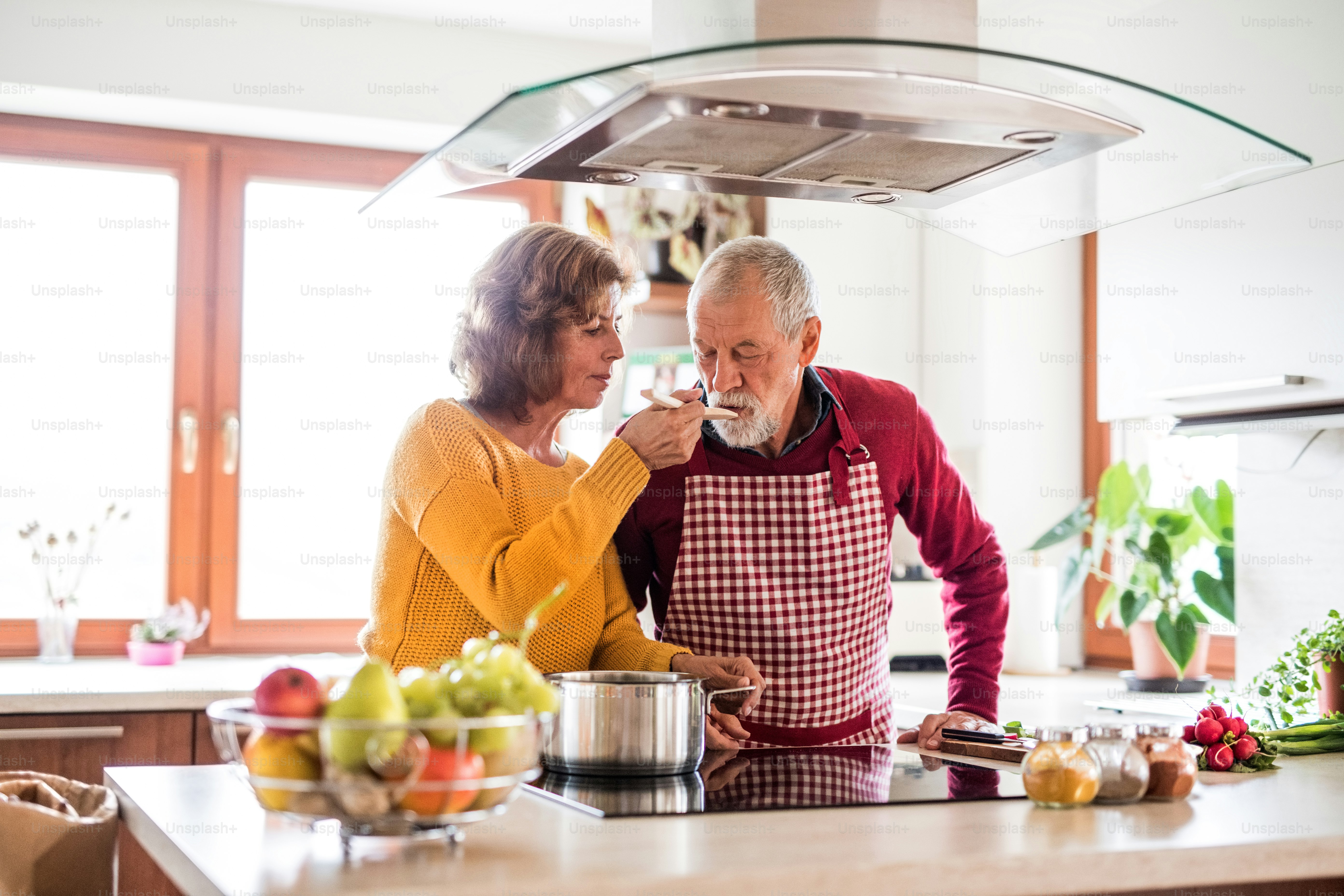 Senior couple preparing food in the kitchen. An old man and woman ...