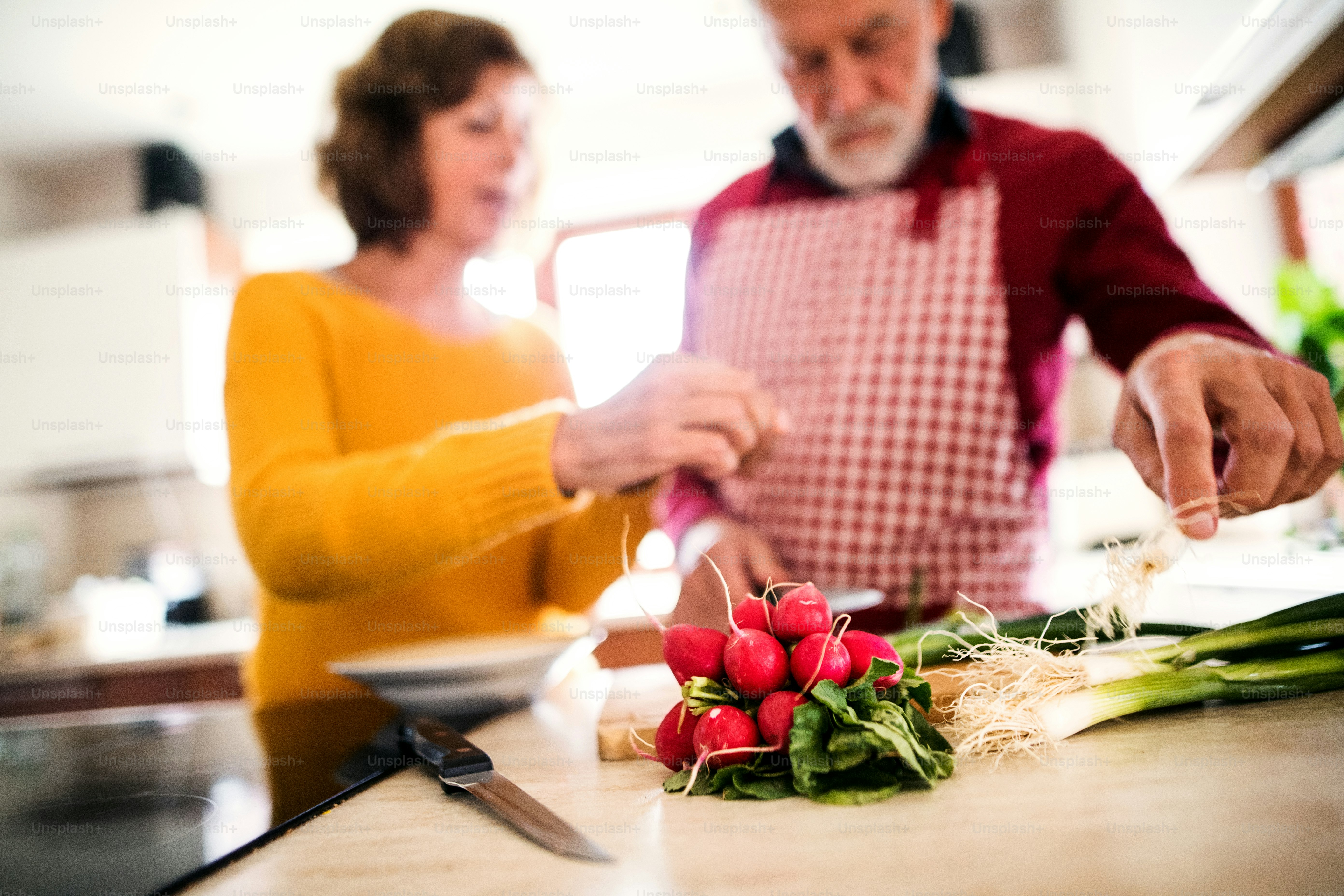 Senior couple preparing food in the kitchen. An old man and woman ...