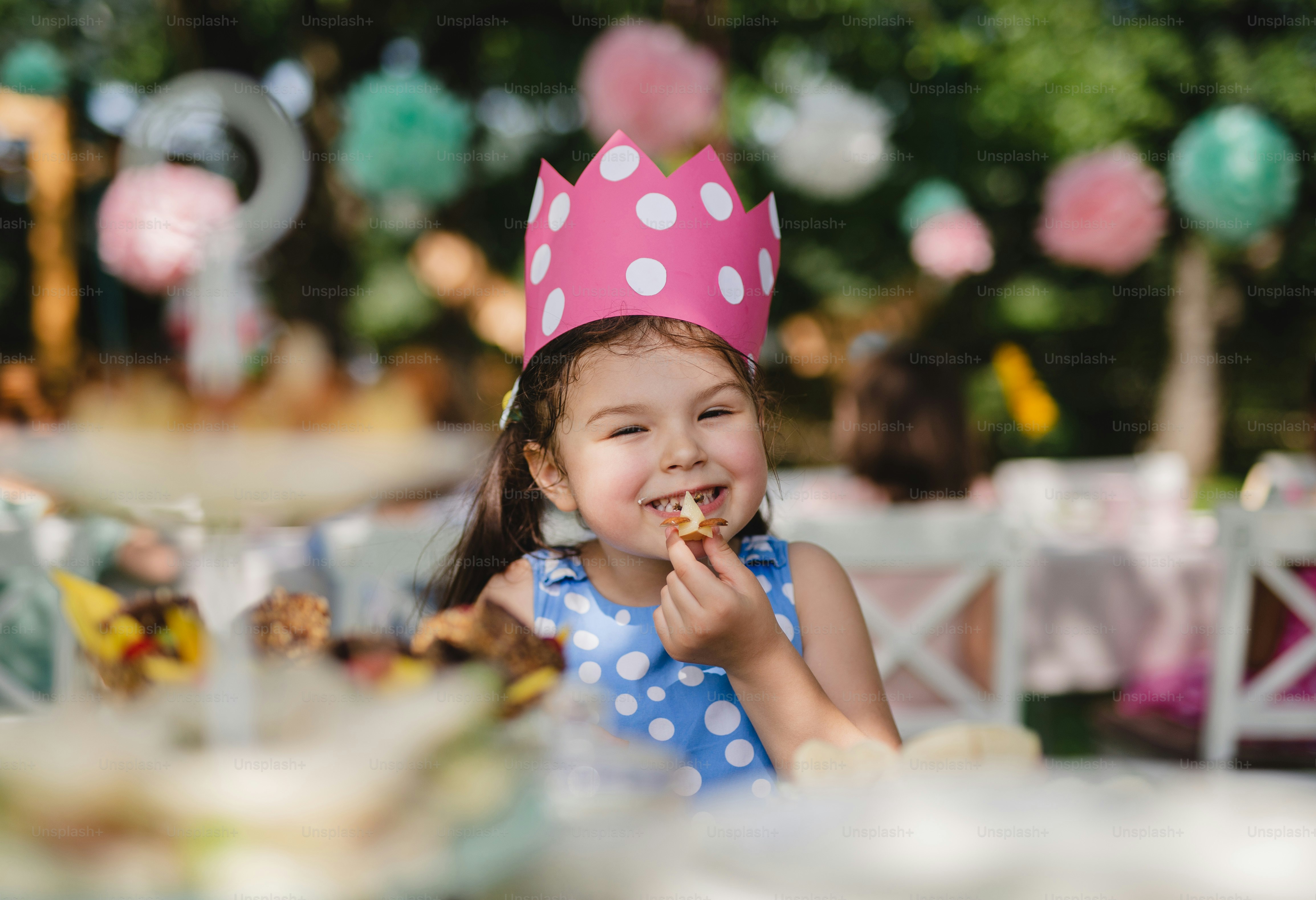 A portrait of children with cake standing around table on birthday ...