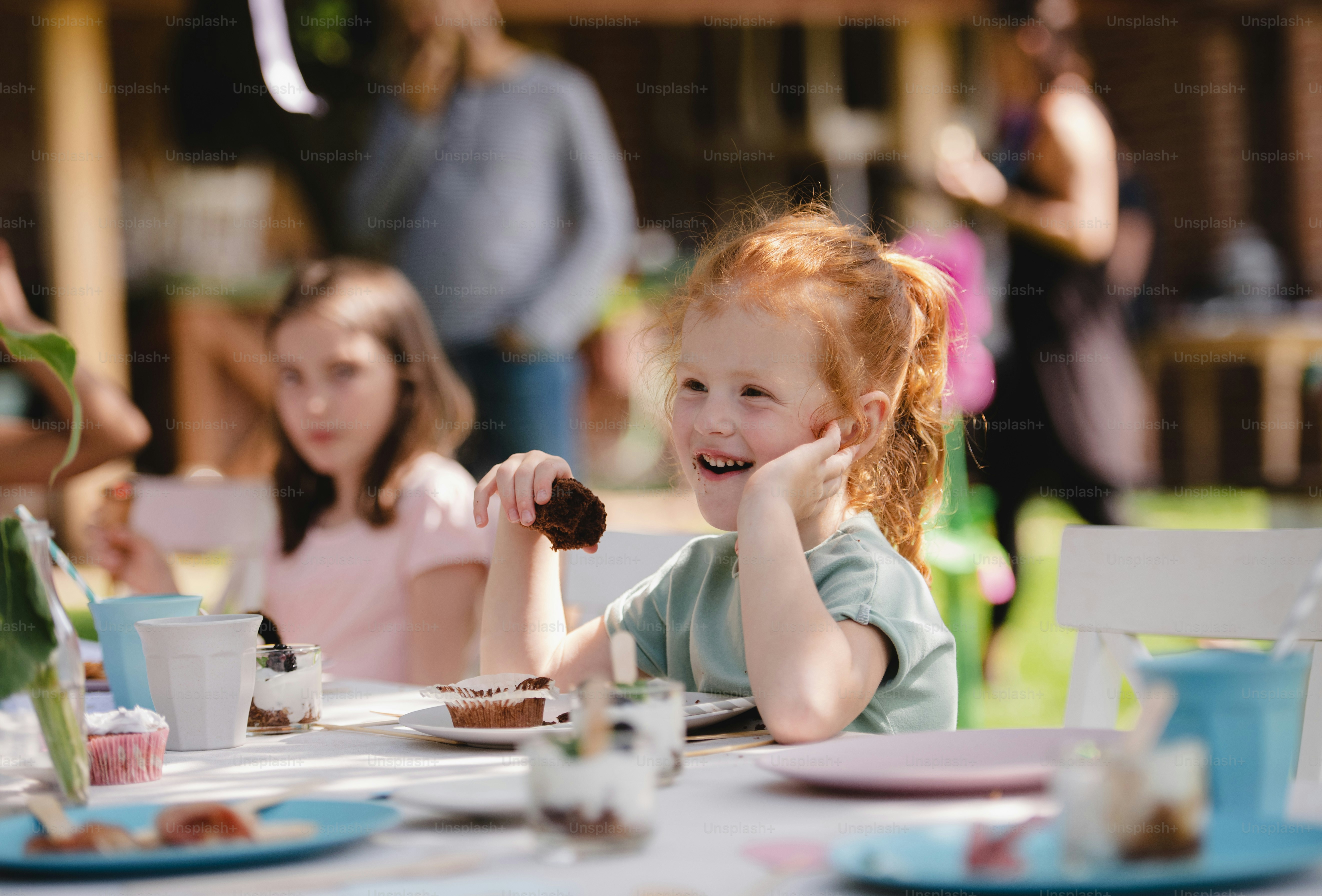 A portrait of children with cake standing around table on birthday ...