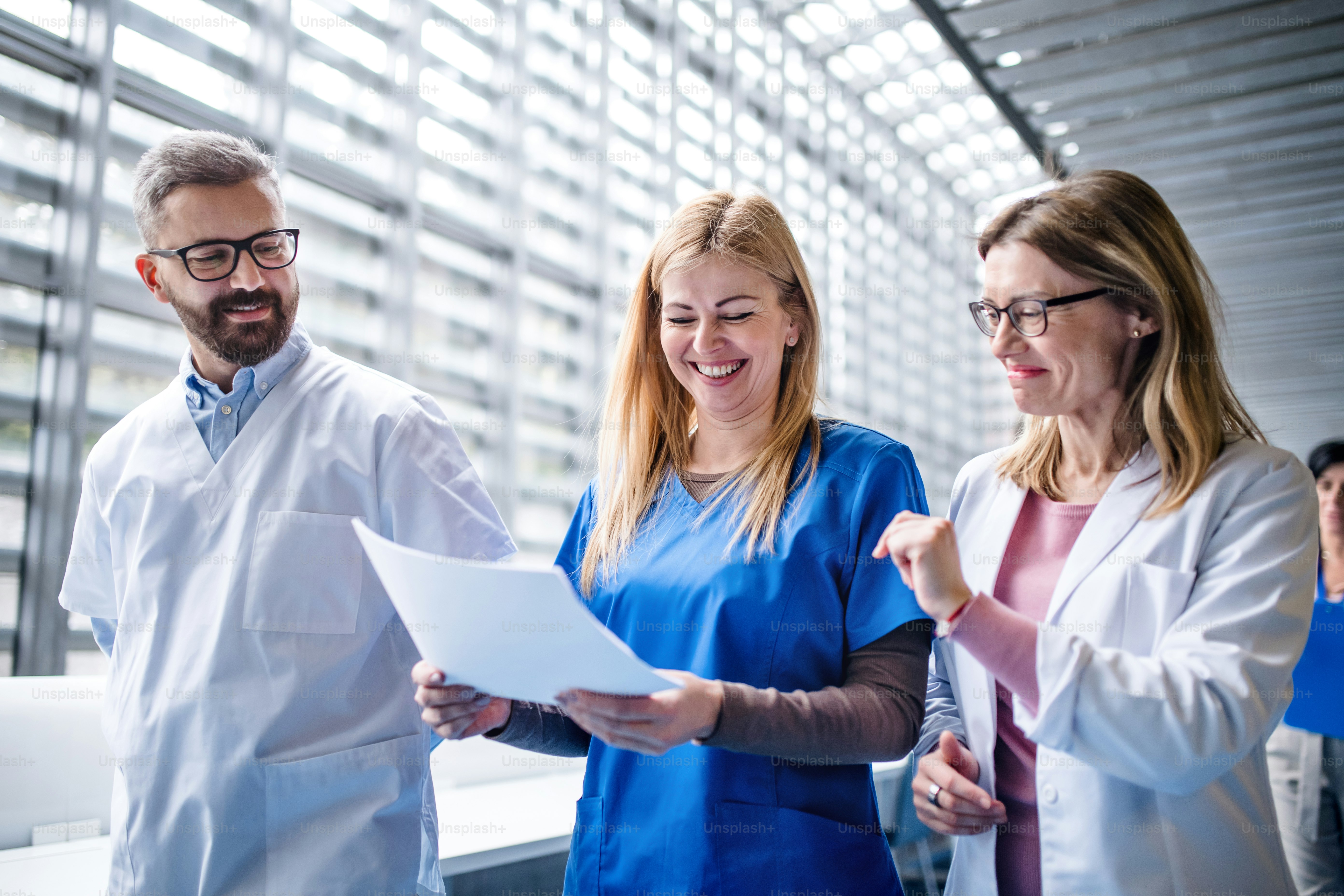 Group of doctors on conference, medical team standing and discussing ...
