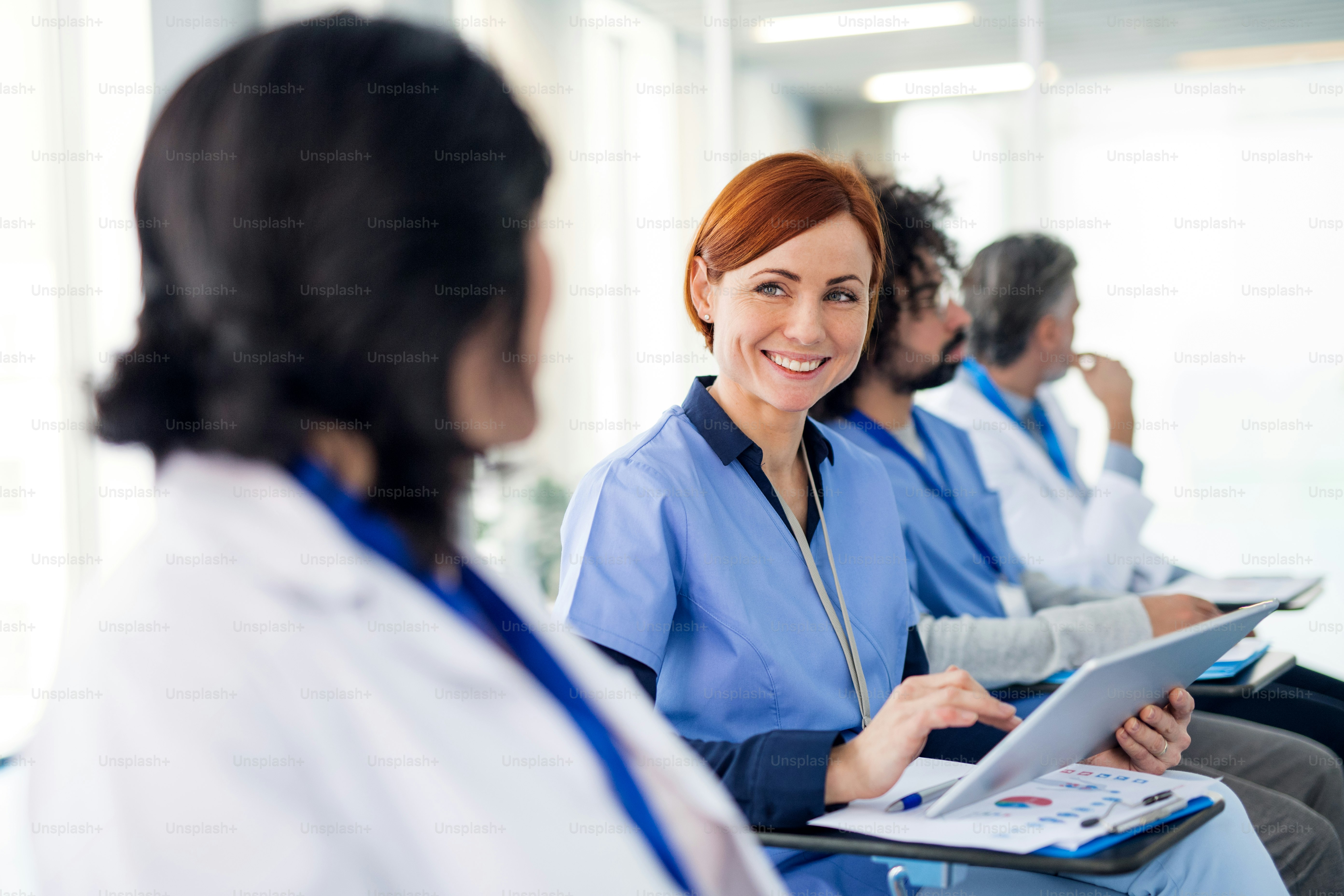 Group of doctors standing on conference, front view portrait of medical ...