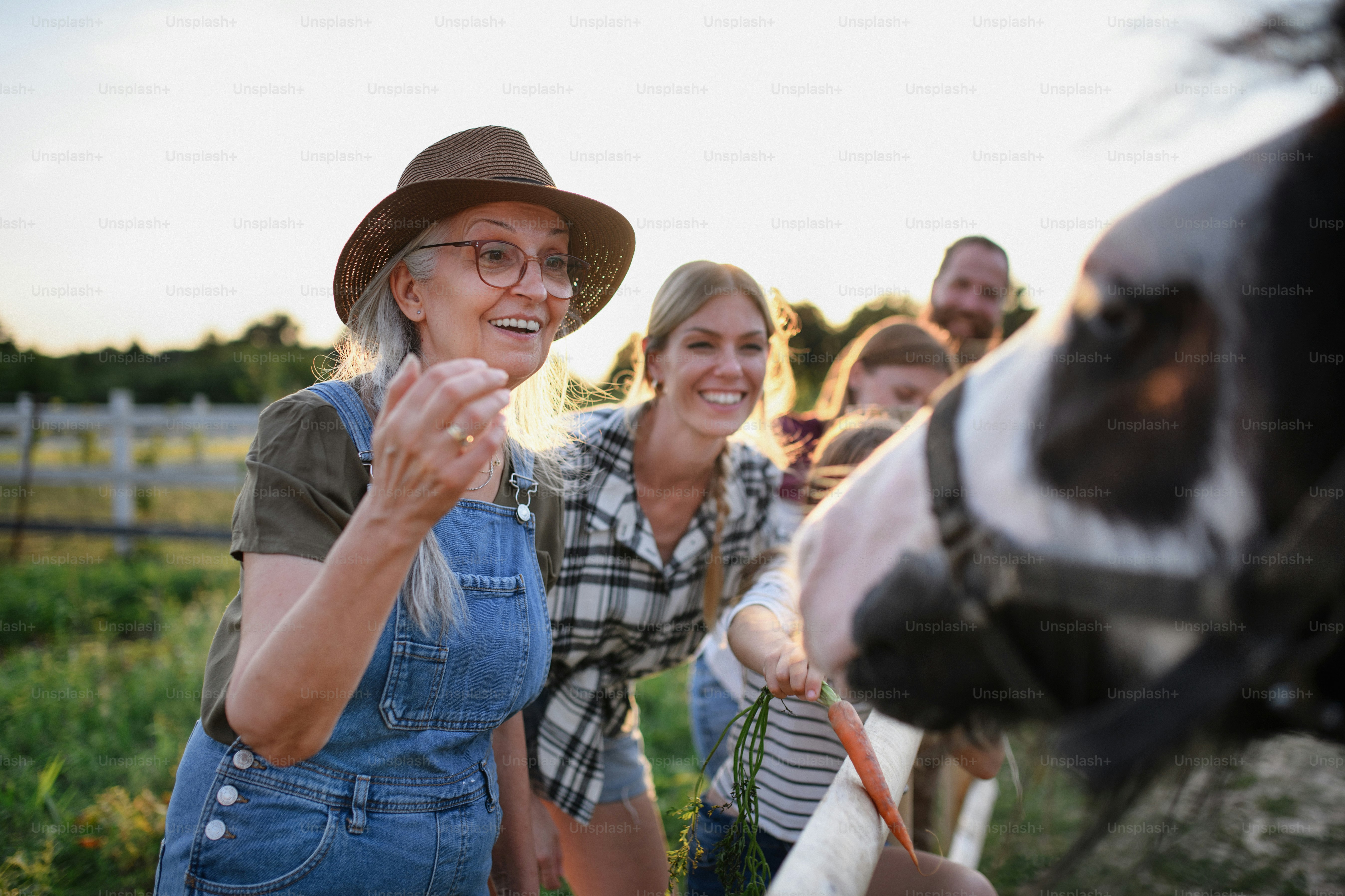 A happy farmers family working with garden tools outdoors at community ...