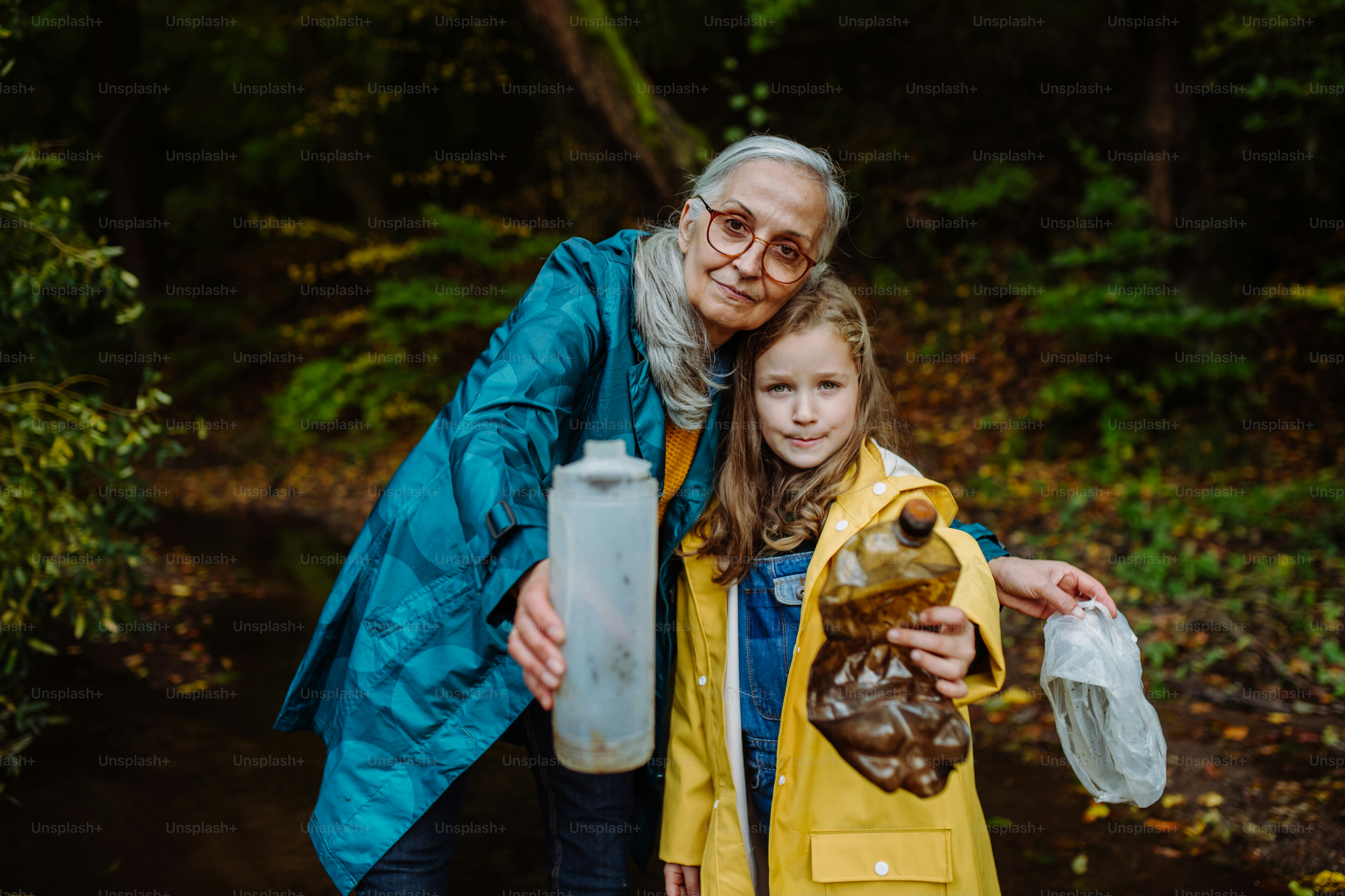 A small girl with grandmother showing plastic waste what they found ...