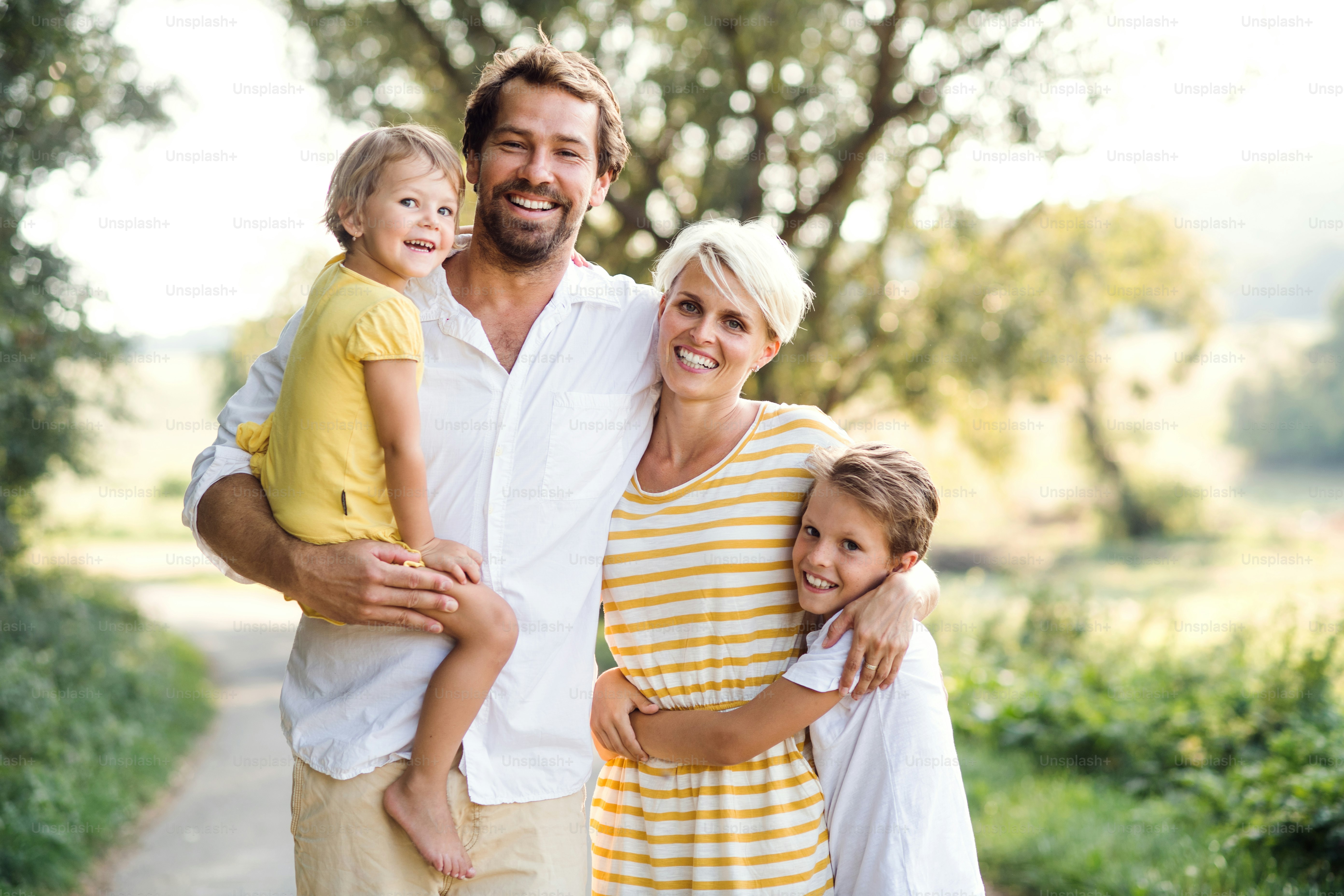 A portrait of happy young family with small children spending time ...