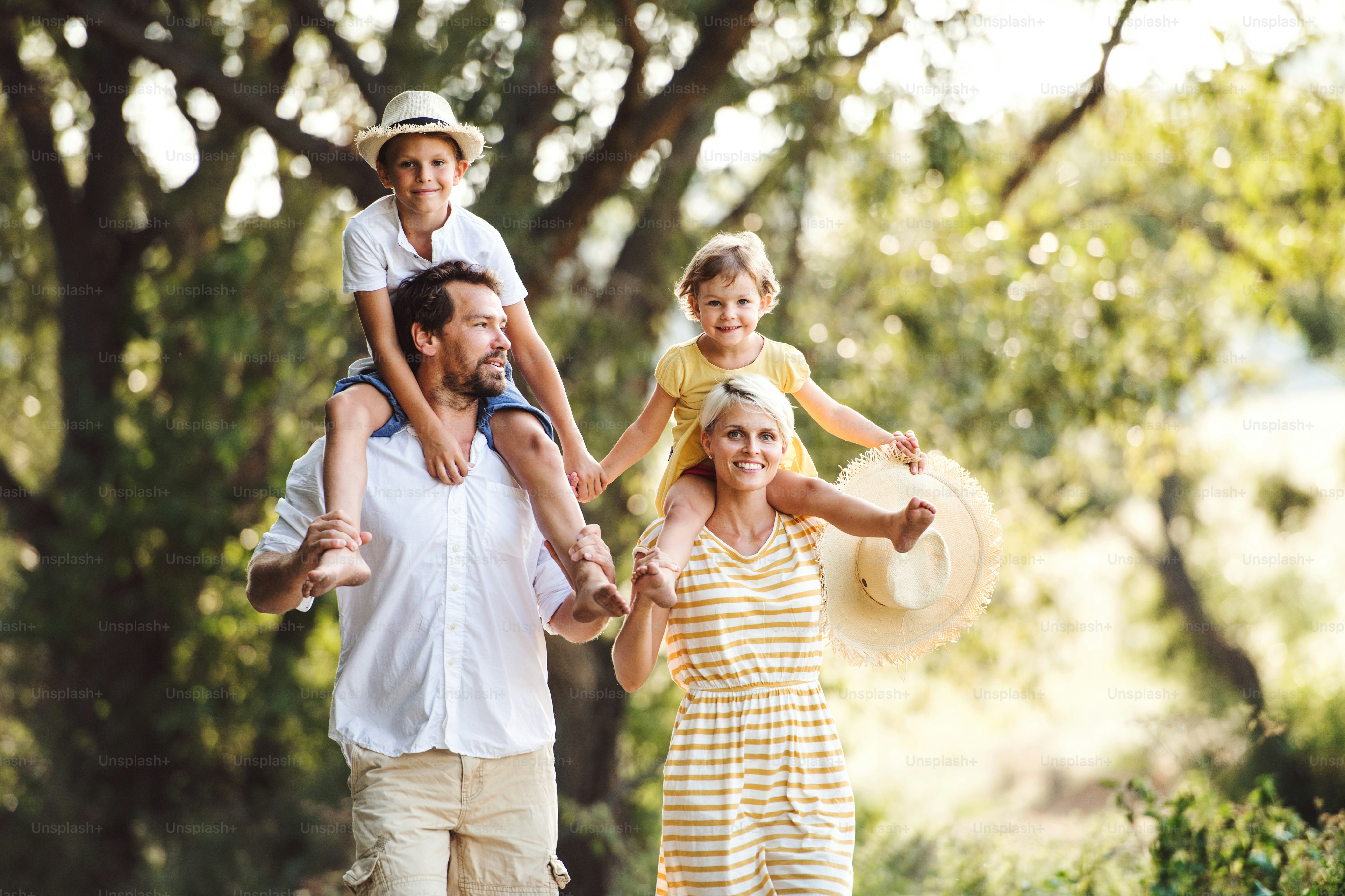 Happy young family with small children spending time together outside ...