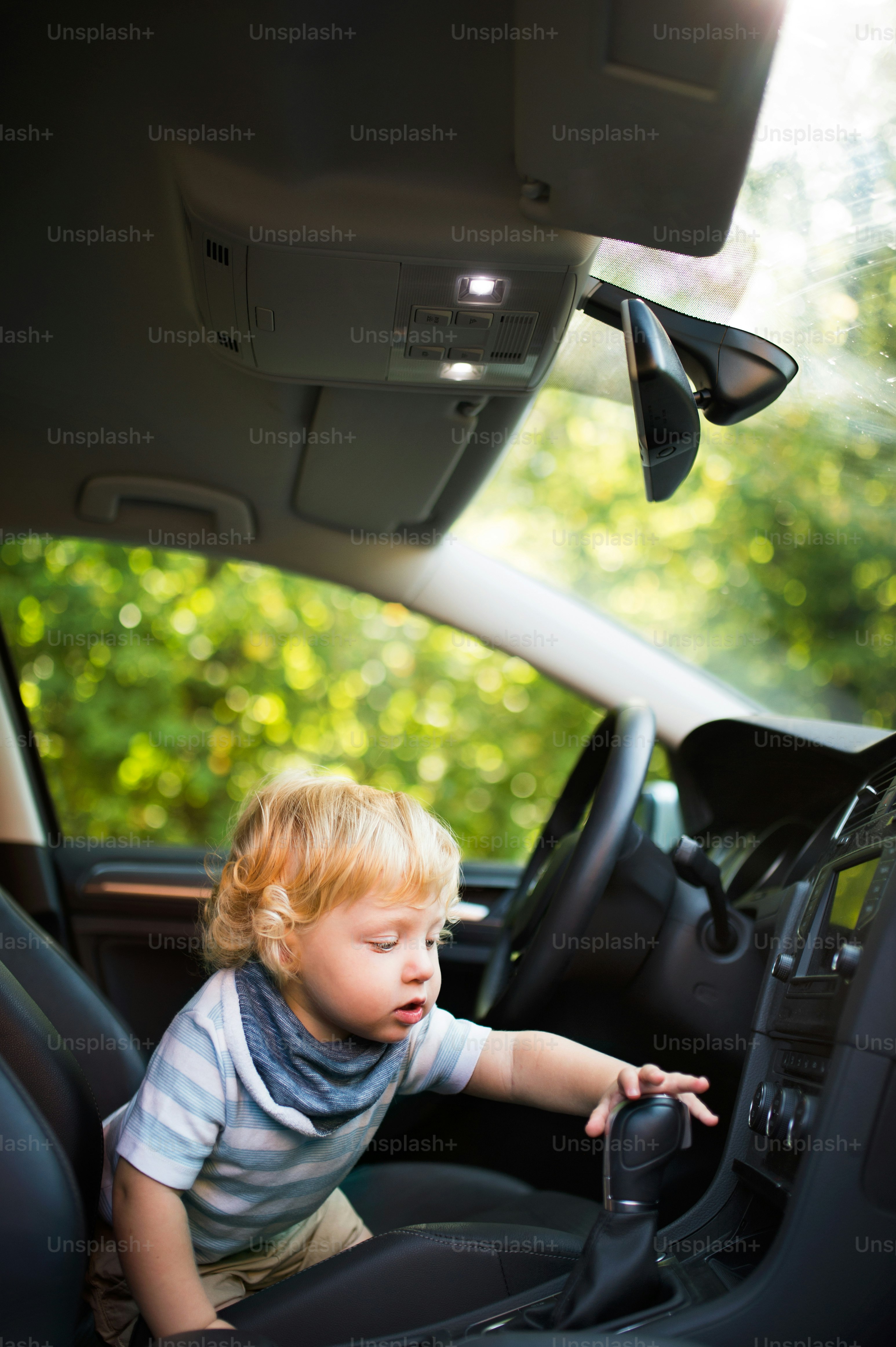 Cute little boy playing in the car, pretending to drive it. photo – Car ...