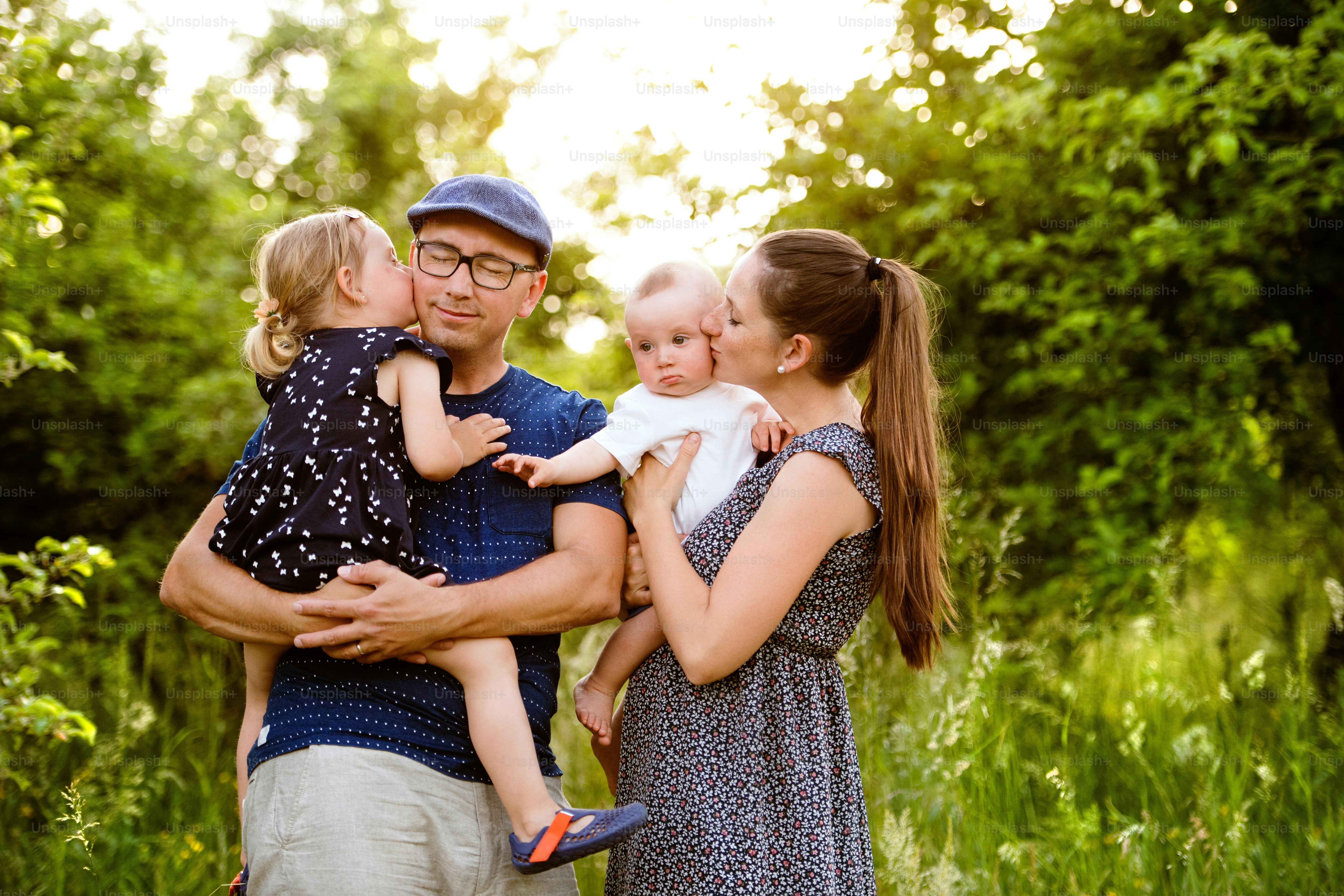 Happy young family with little children spending time together outside ...