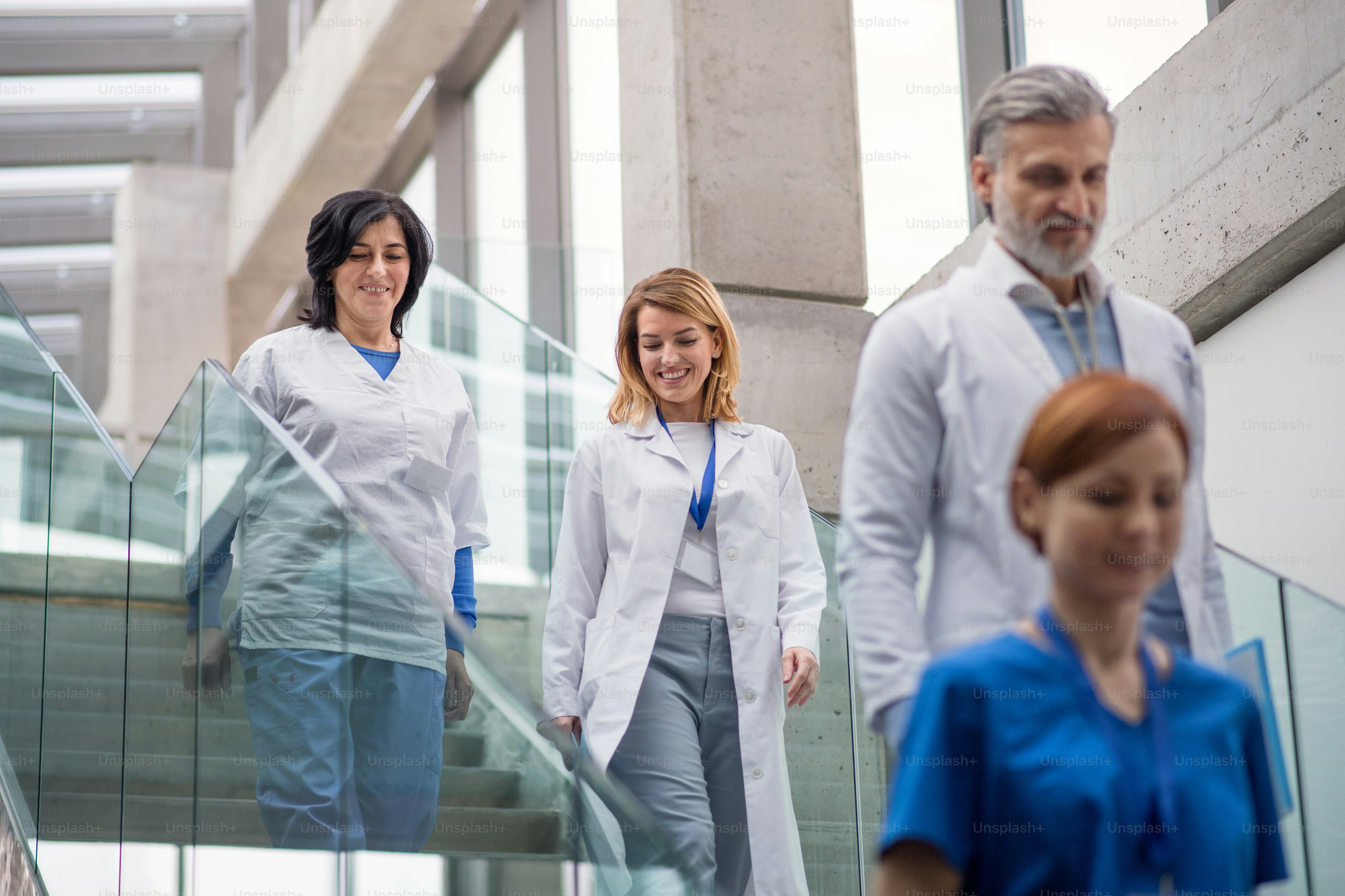 Group of doctors on conference, medical team standing and discussing ...