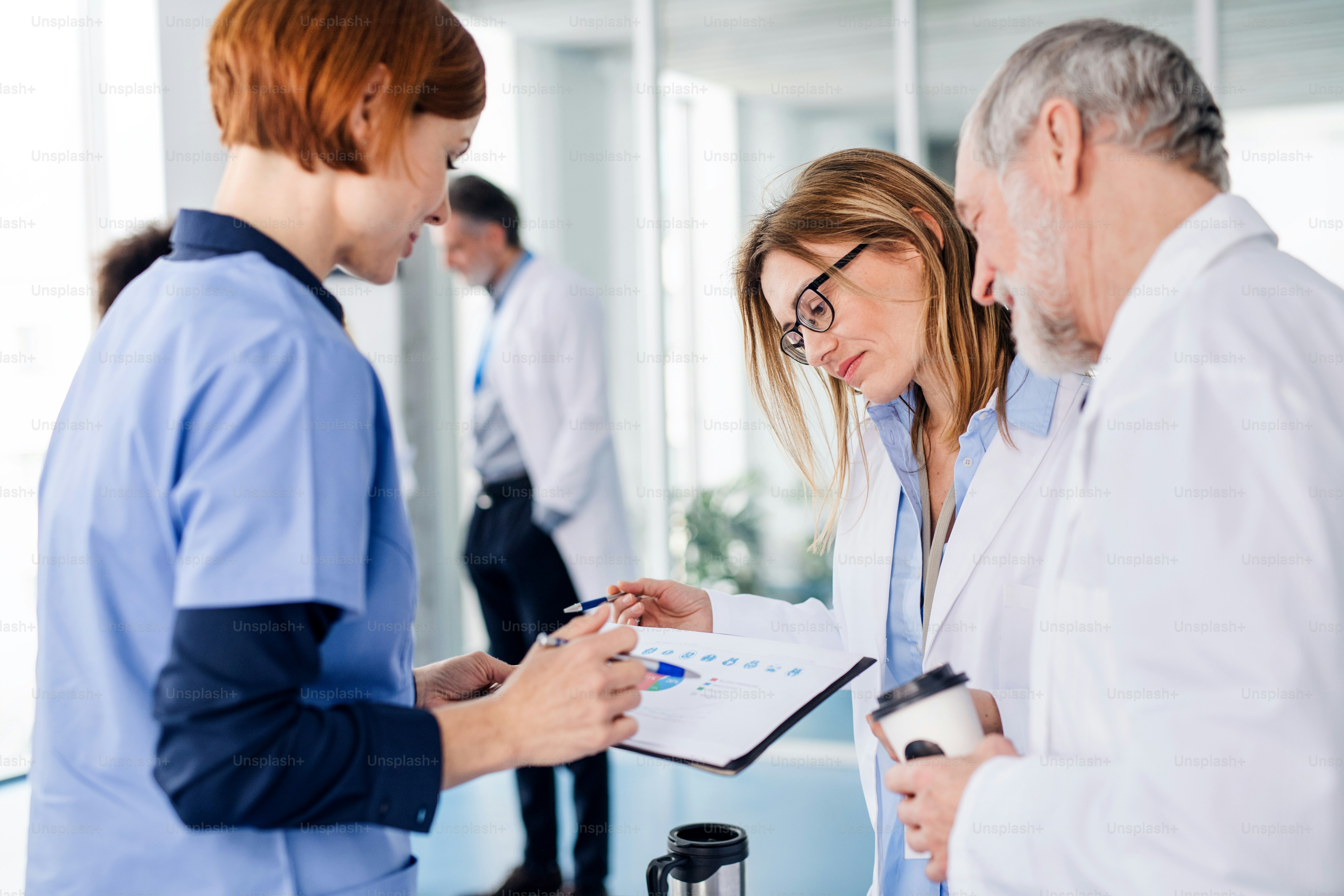 Group of doctors on conference, medical team standing and discussing ...