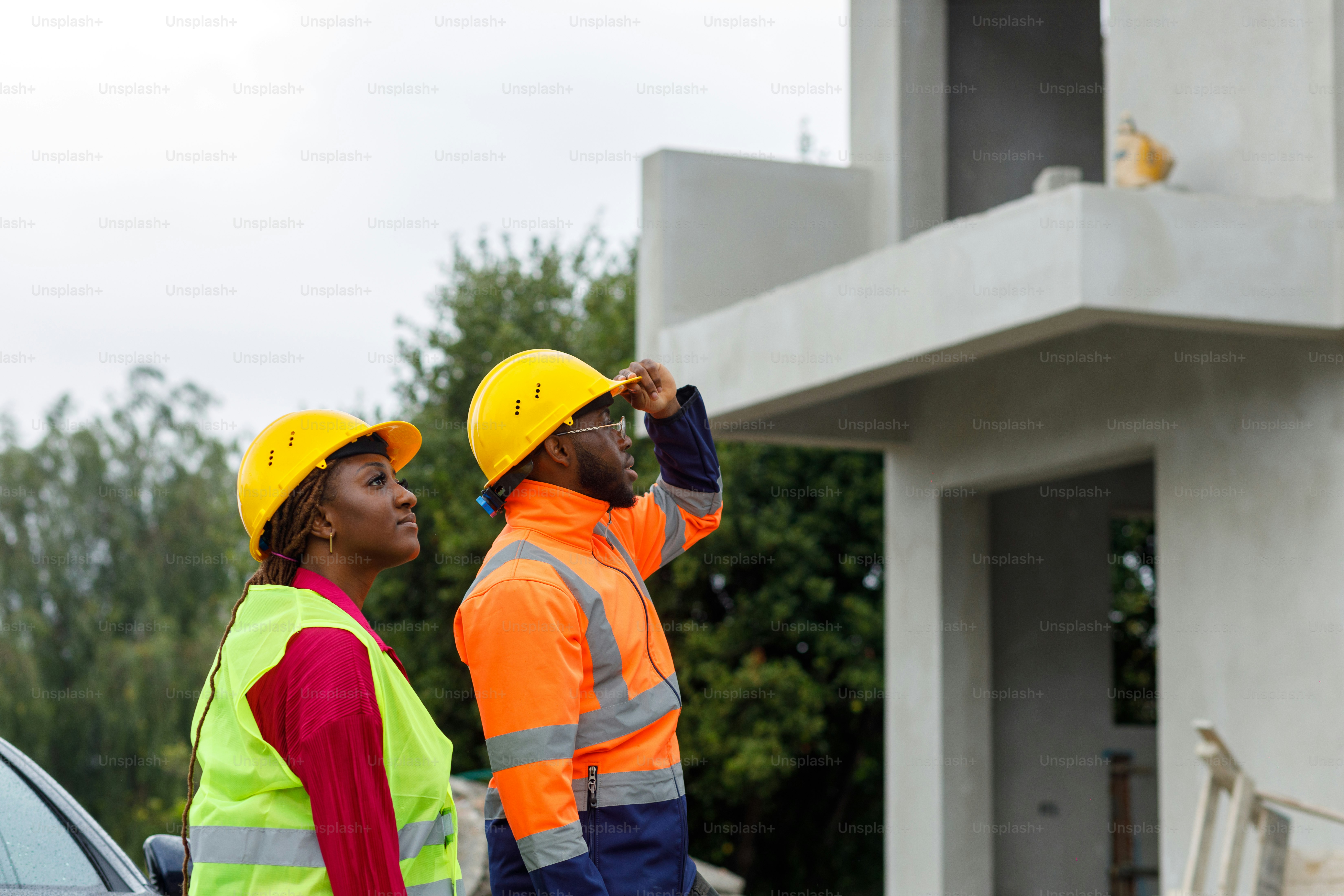 A couple of construction workers standing next to each other photo ...